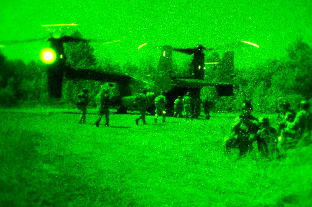 As seen through a night-vision device, an Air Force CV-22 Osprey ...
