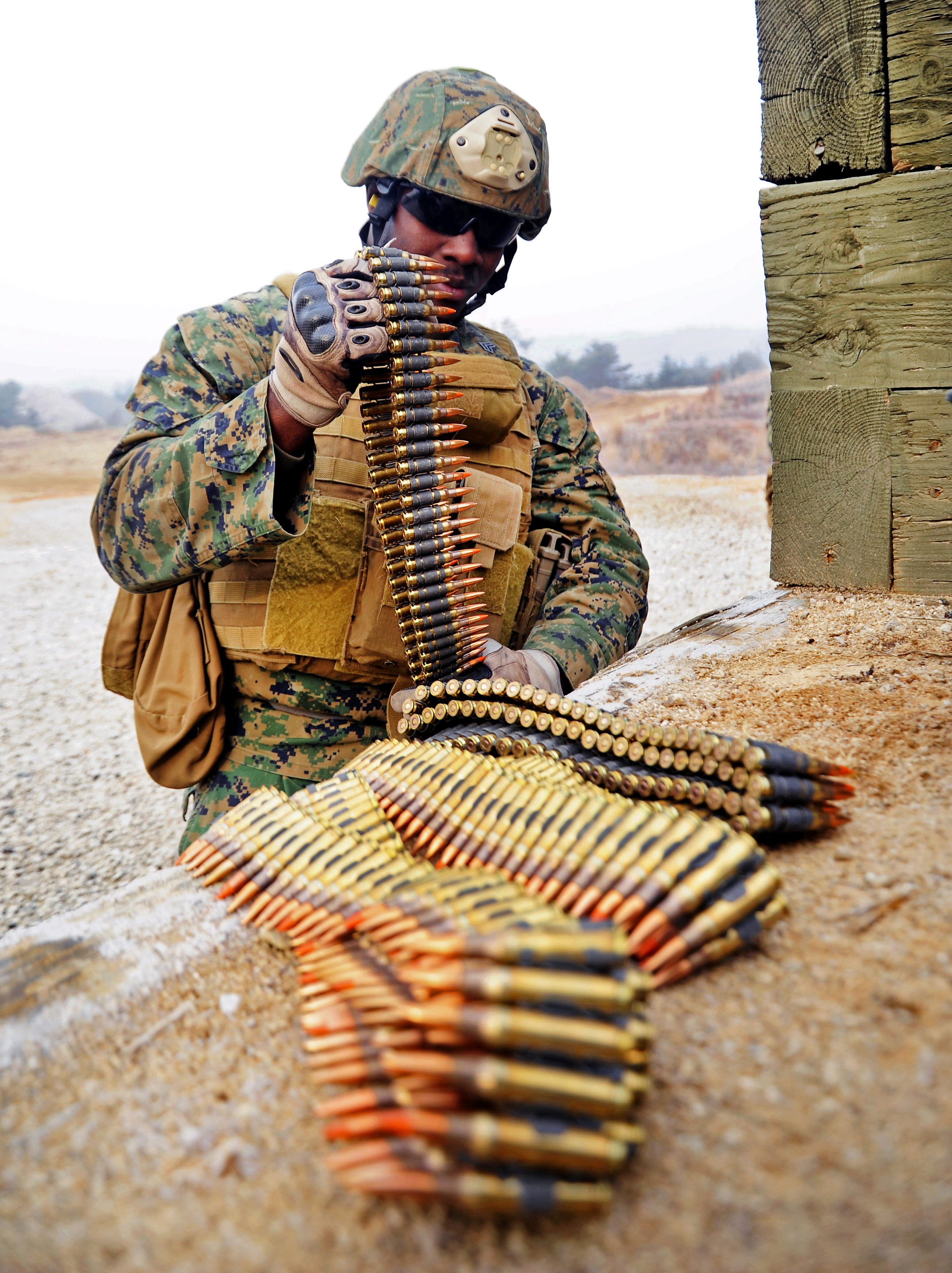 U.S. Marine Corps Sgt. Wendall Claxton readies M240 machine gun ammo ...