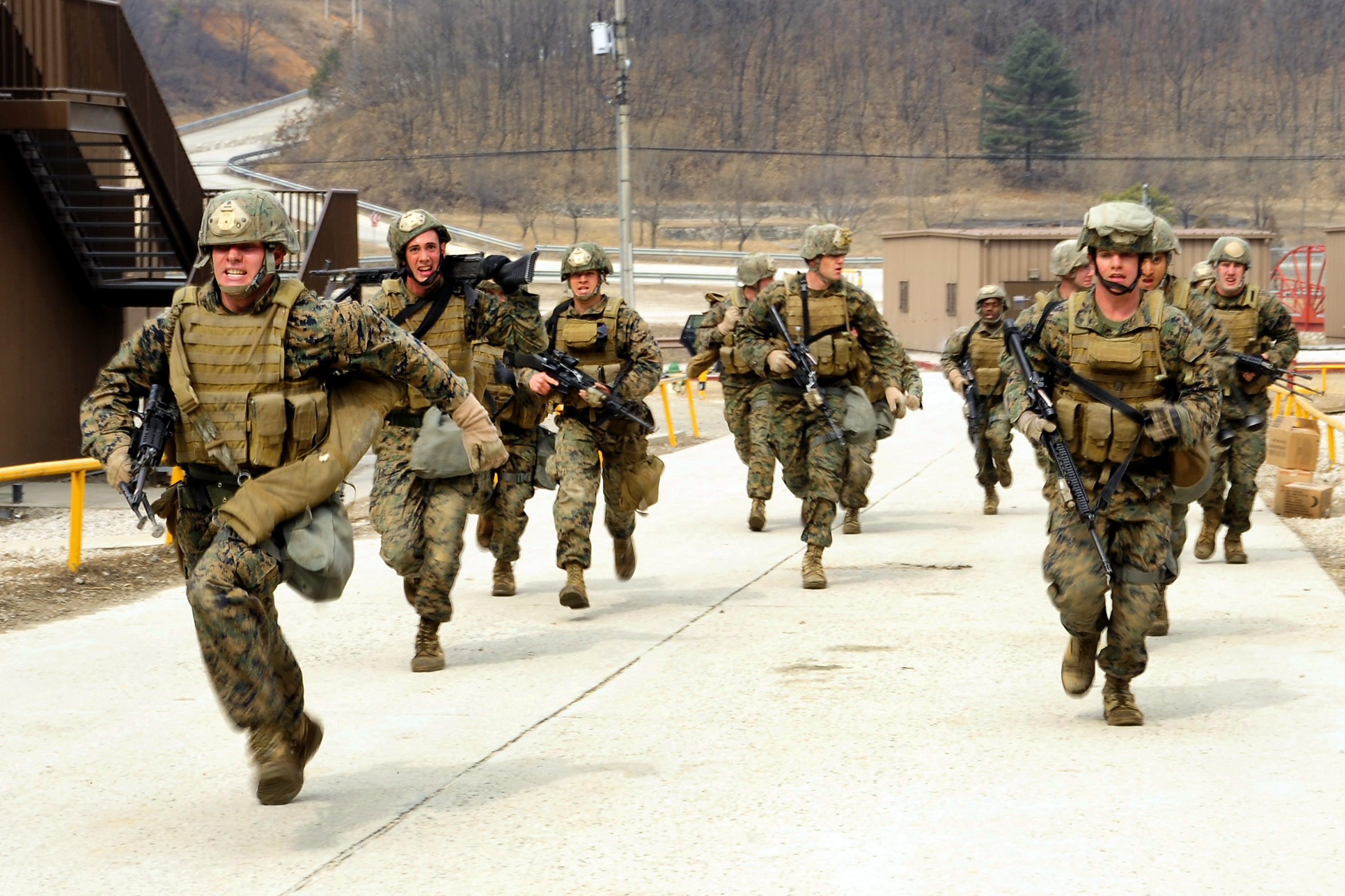 U.S. Marines run while conducting a tactical movement exercise on Camp ...