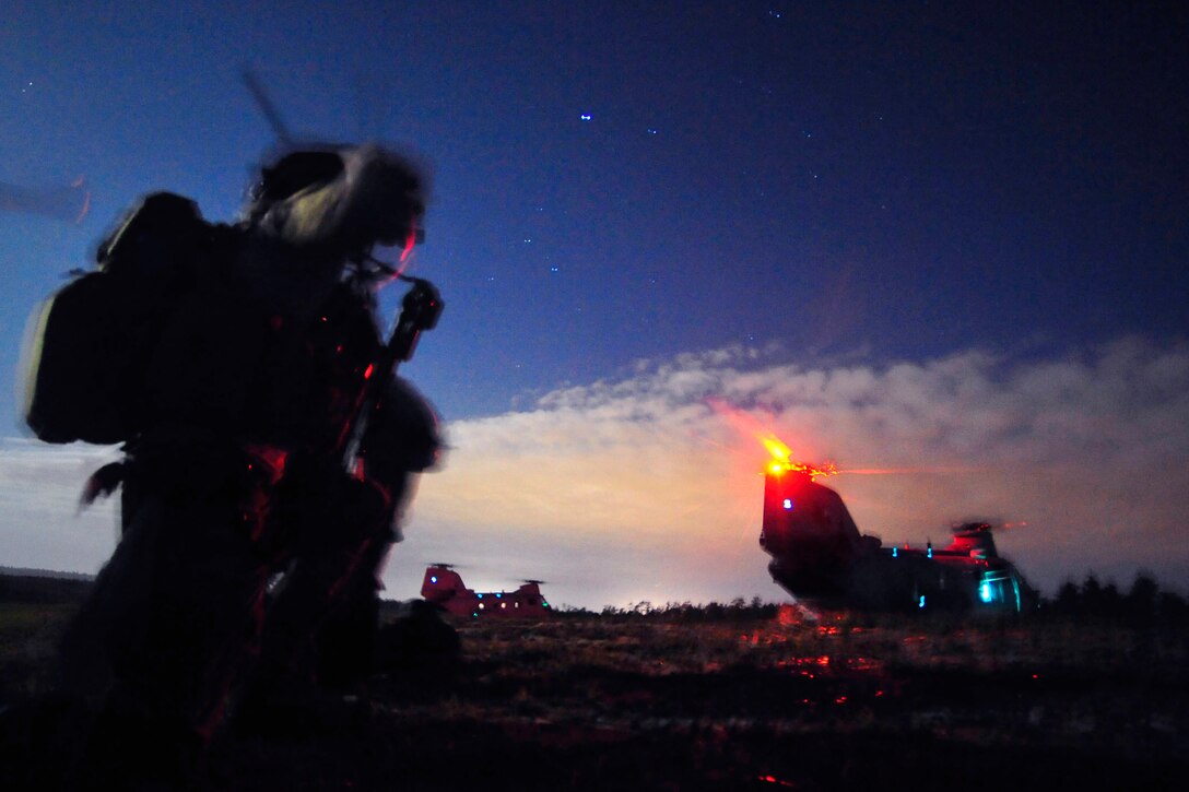 Soldiers pull perimeter security for several helicopters while ...
