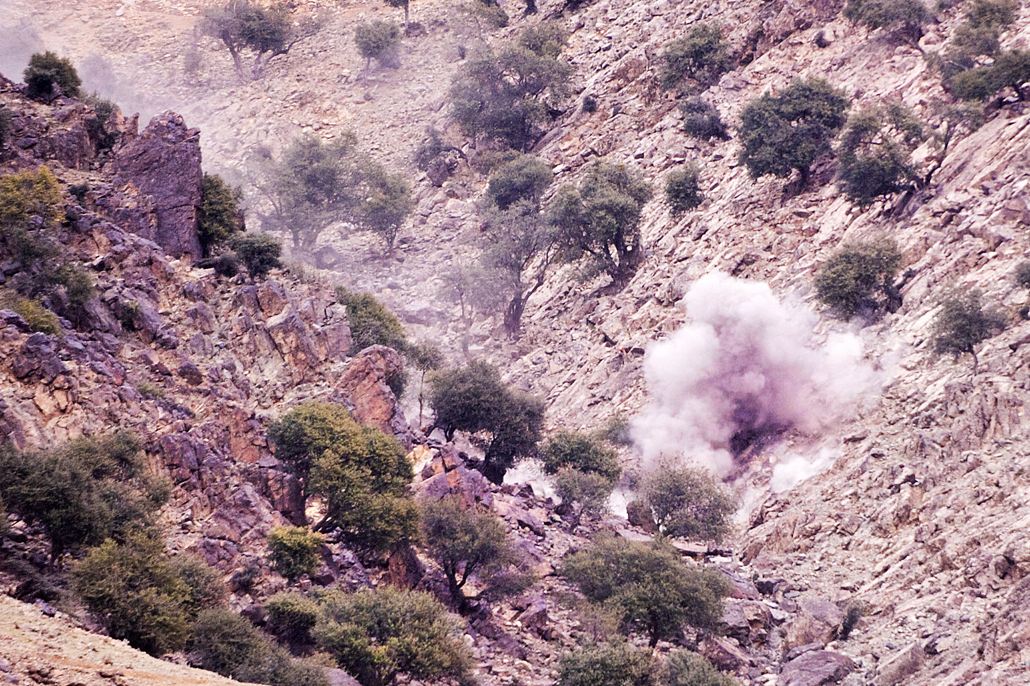 A high-explosive rocket detonates during a firefight in the Sar Kani ...