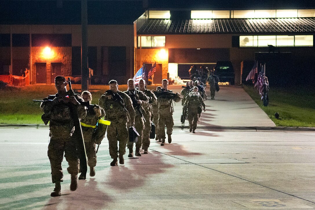 Soldiers leave “Green Ramp” on Pope Field to board an aircraft bound ...