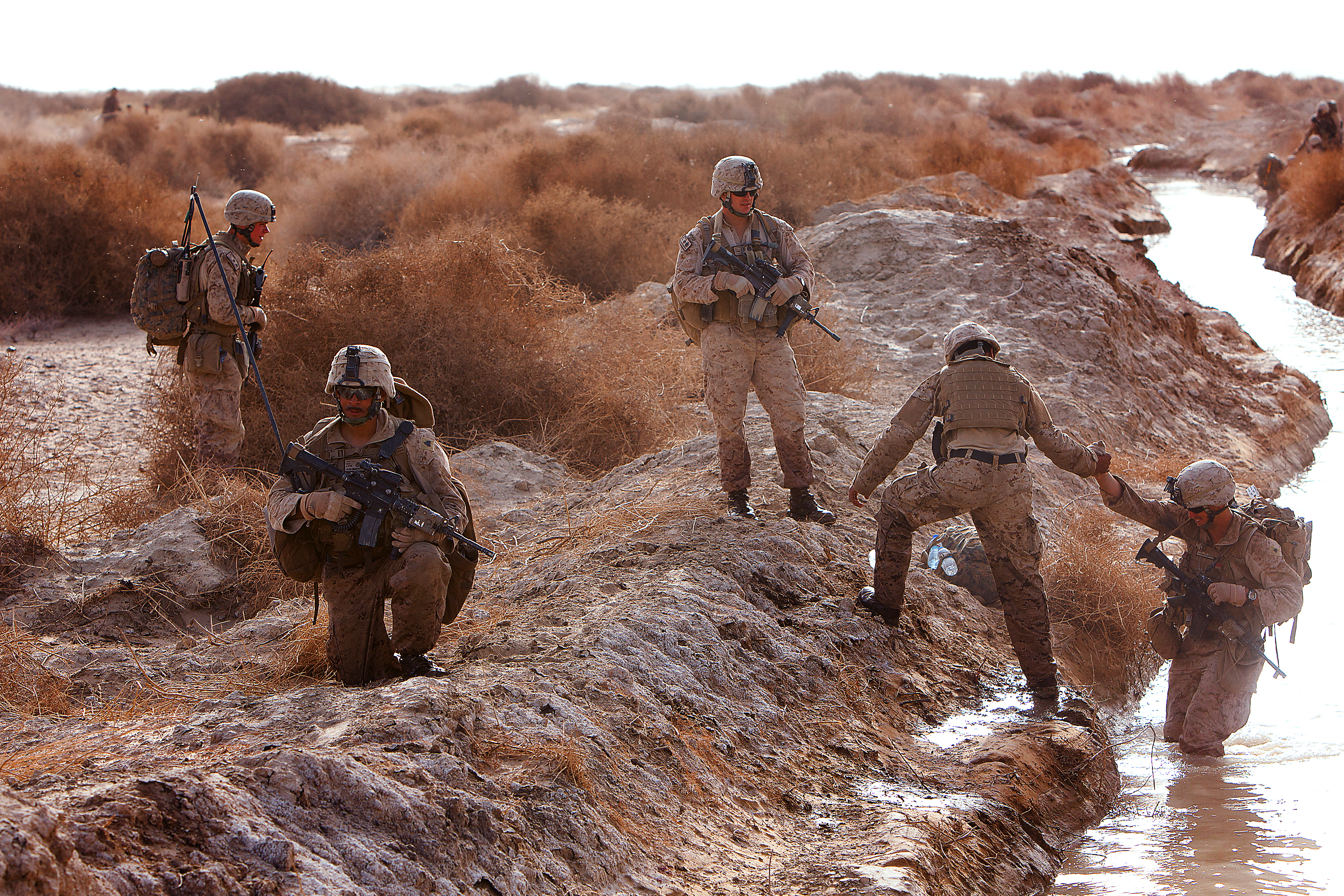 U.S. Marines cross a canal as they head to an overnight post in ...