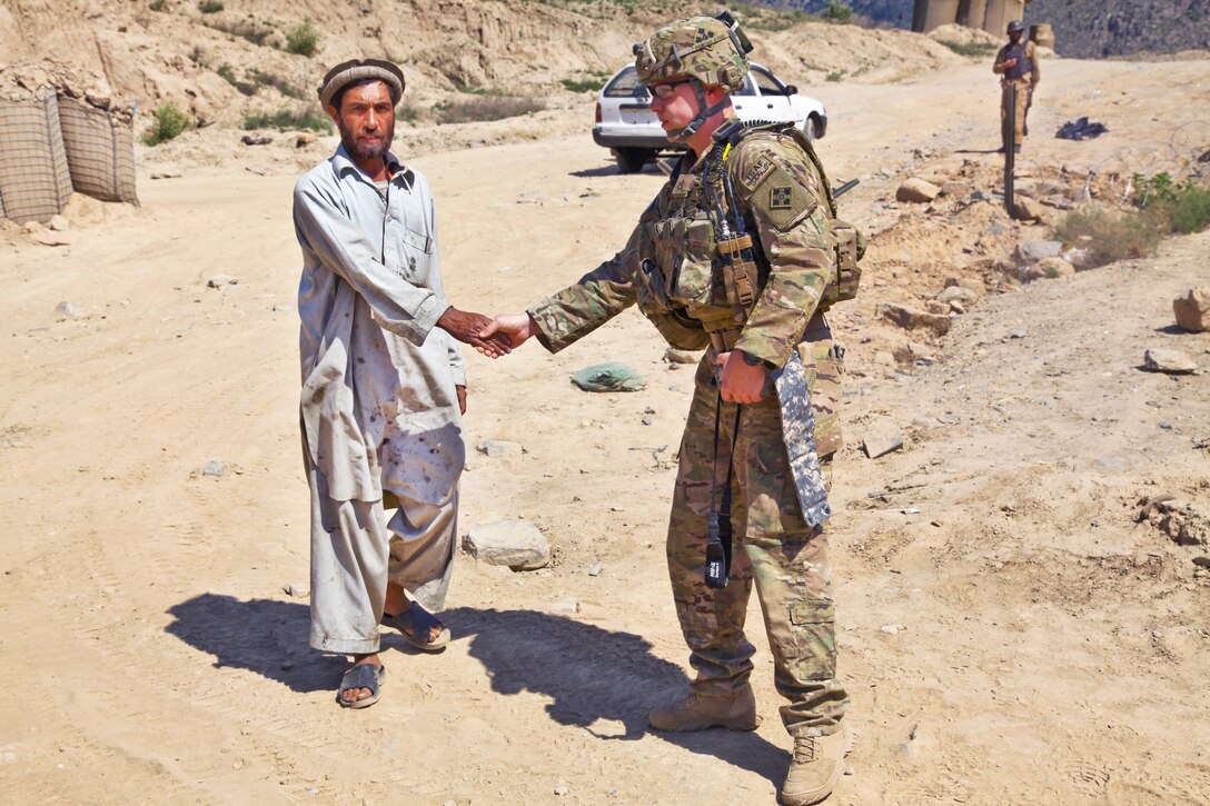 U.S. Army Staff Sgt. Ryan Markle shakes hands with an Afghan man on ...