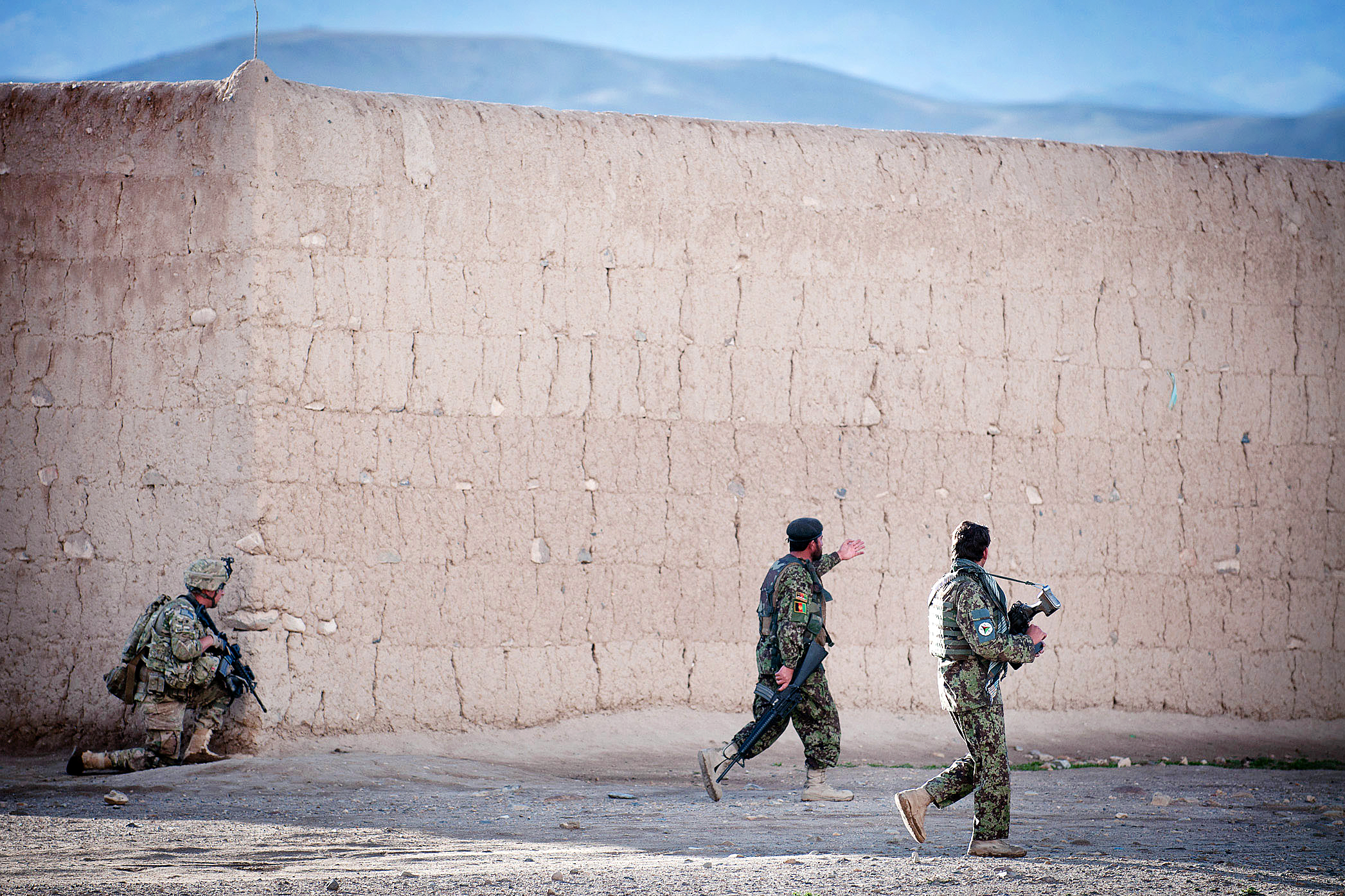 U.S. Army Spc. Jason Castaneda pulls security as two Afghan soldiers ...