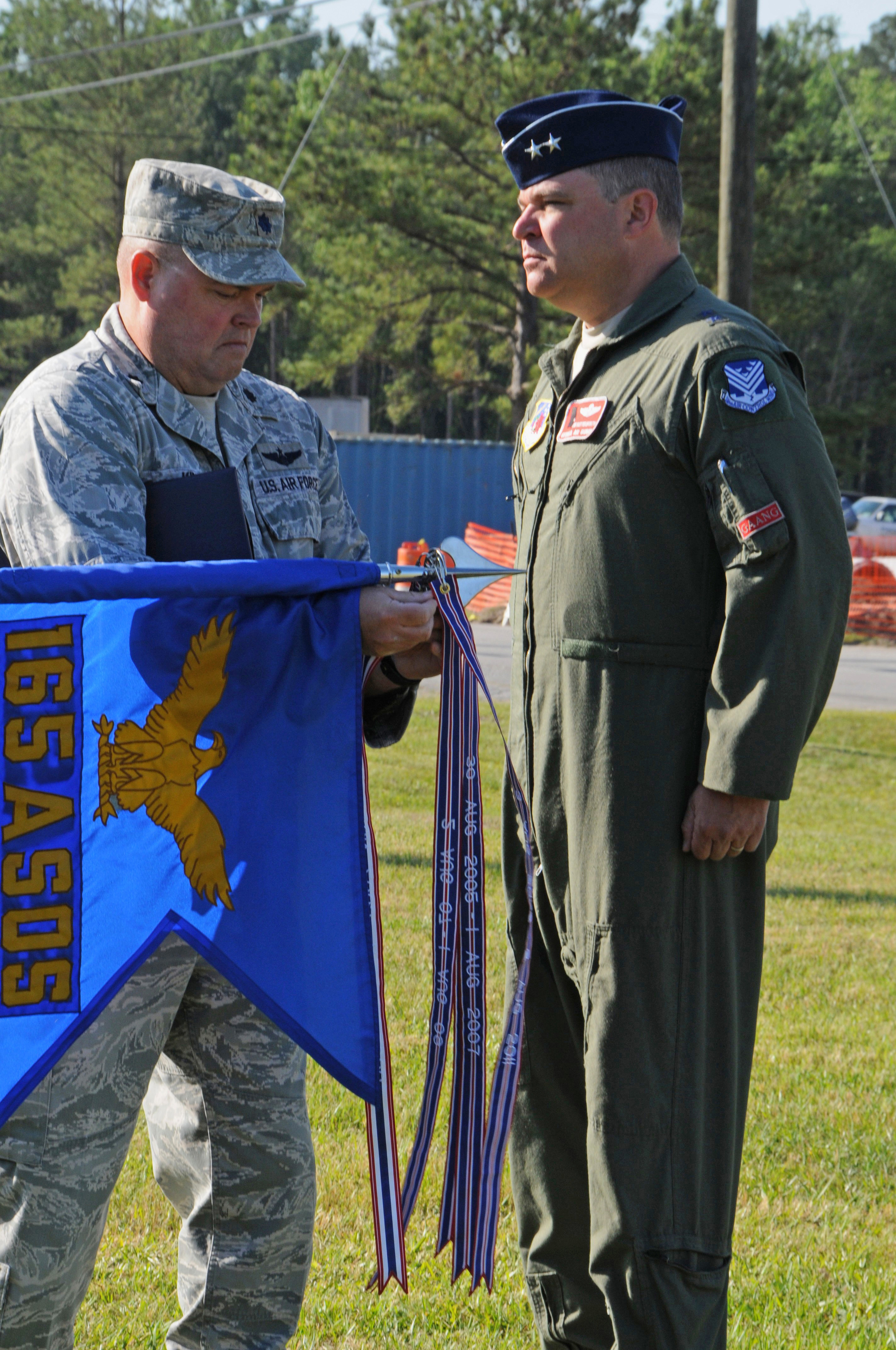 Lt. Col. Timothy King attaches AFOUA and MUA streamers to 165th ASOS ...