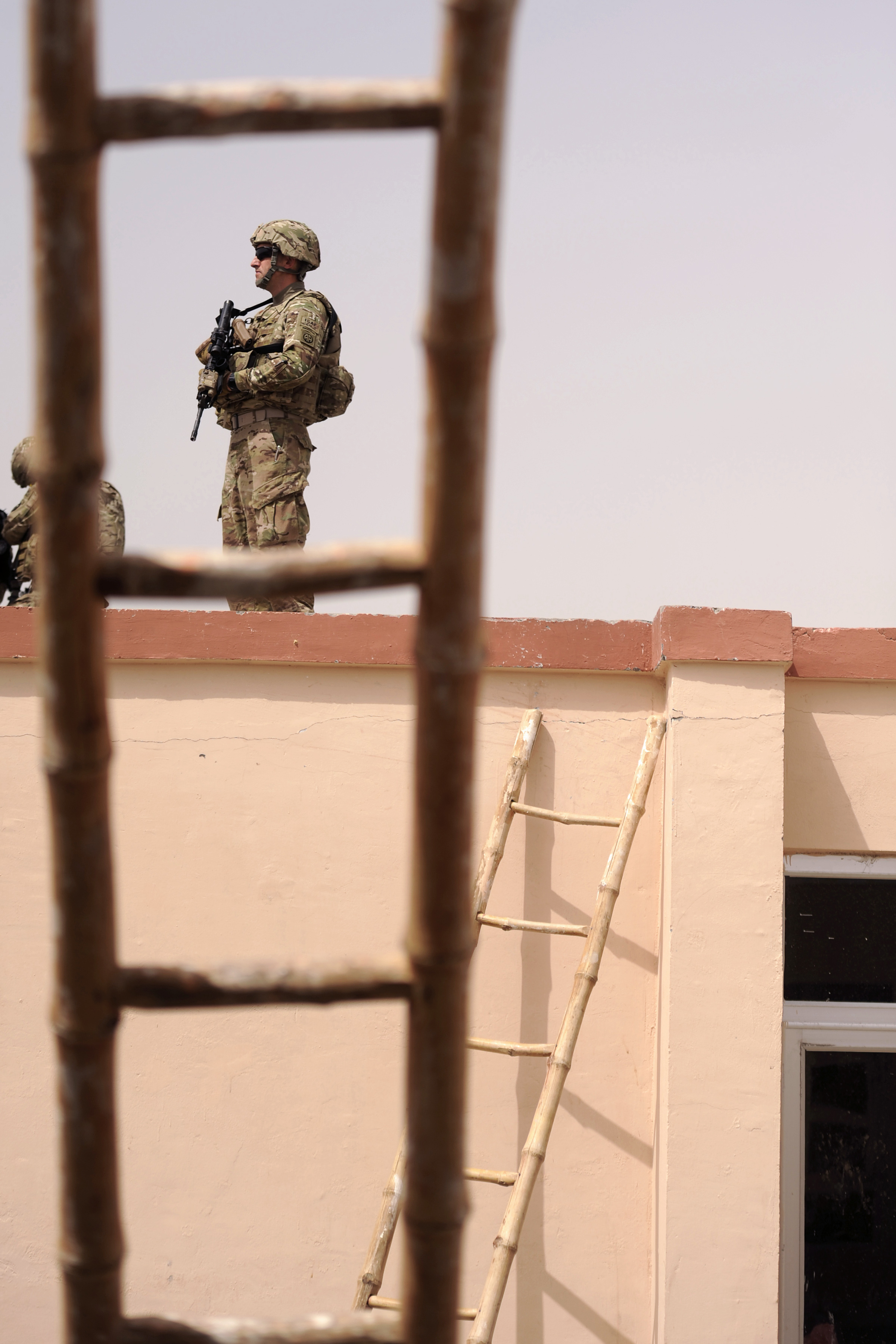 U.S. Navy Lt. Cmdr. Mark Wagner provides security from the roof top of ...