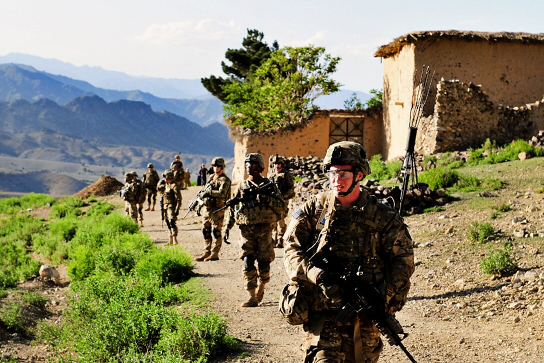 U.S. Army paratroopers and Afghan soldiers patrol a village in the Tani ...
