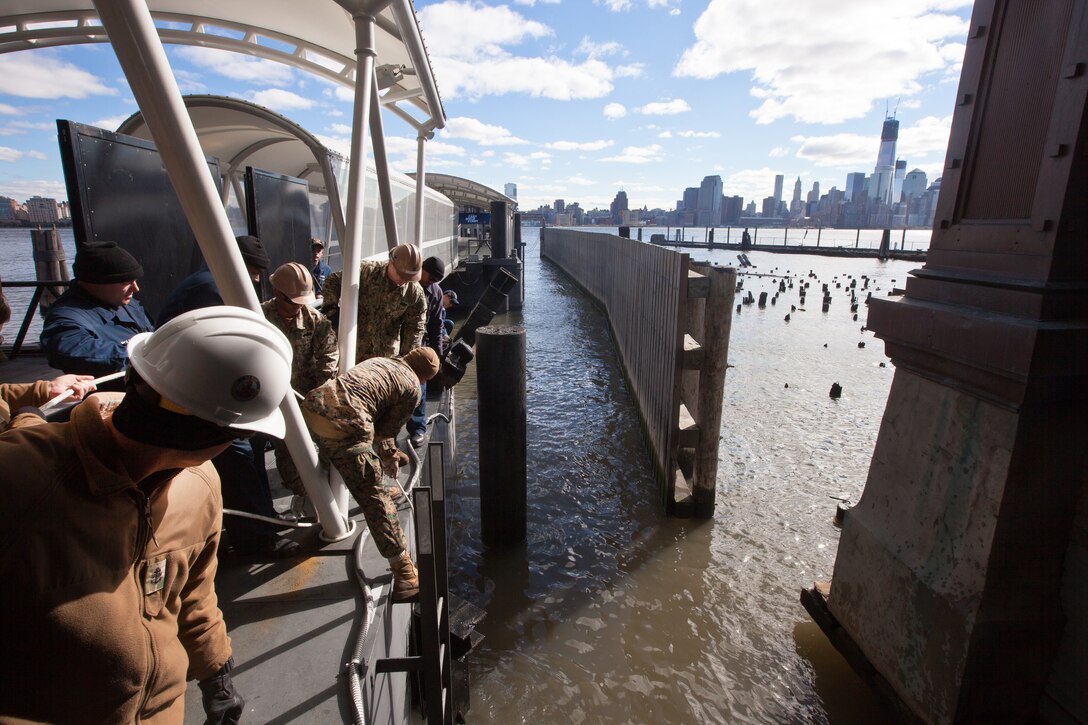 Navy Seabees works to repair pier facilities in Hoboken, N.J., Nov. 3 ...