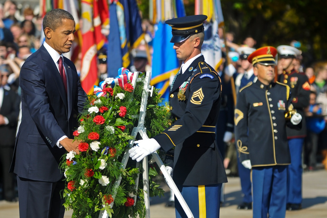 President Barack Obama and Army Sgt. 1st Class Chad Stackpole lay a ...