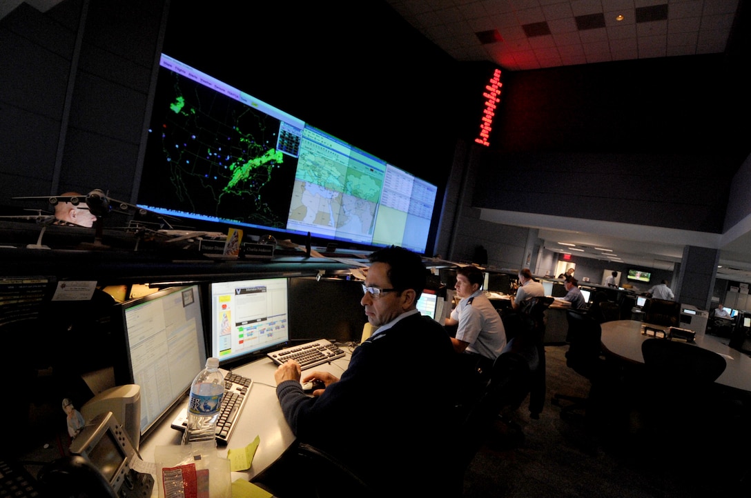 Members of the 618th Tanker Airlift Control Center use information ...