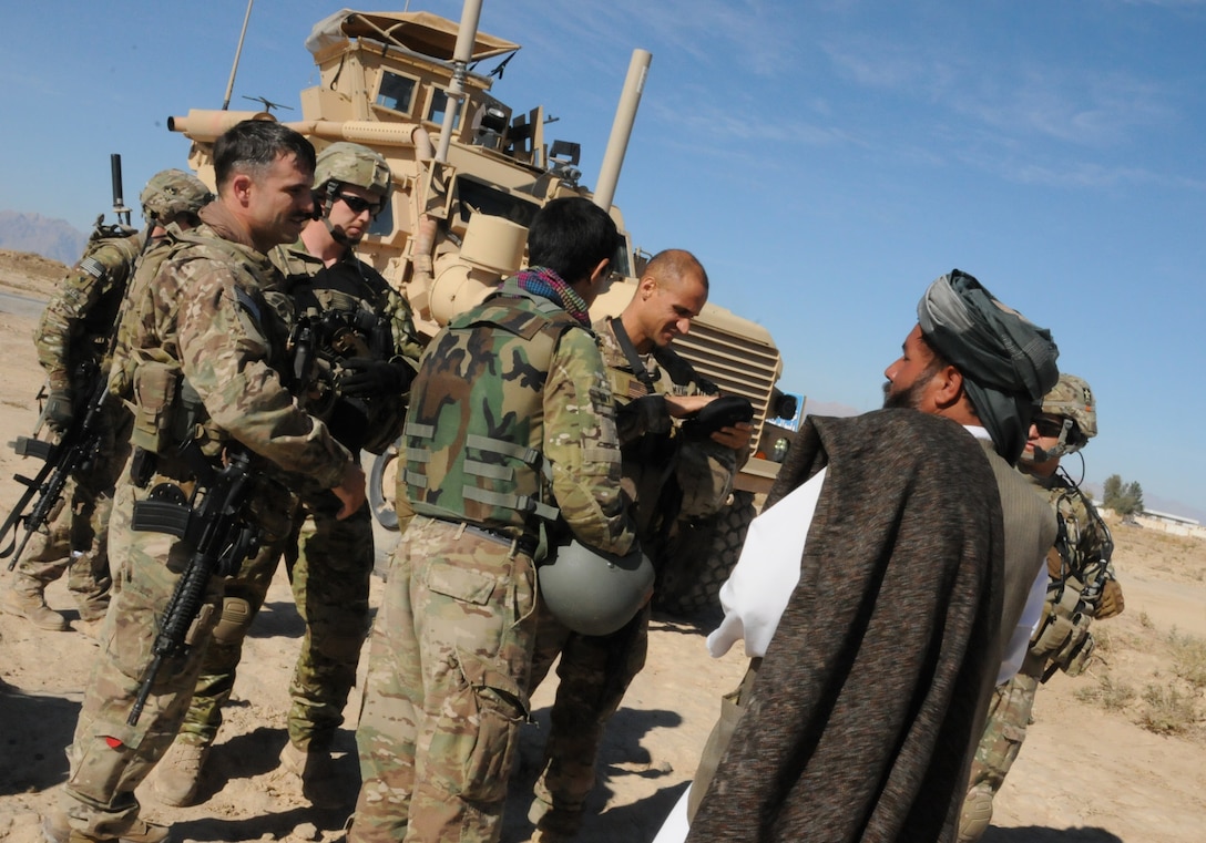 U.S. Navy Cmdr. Lou McCray, center, U.S. Army Cpt. Jeremiah Gebhart ...