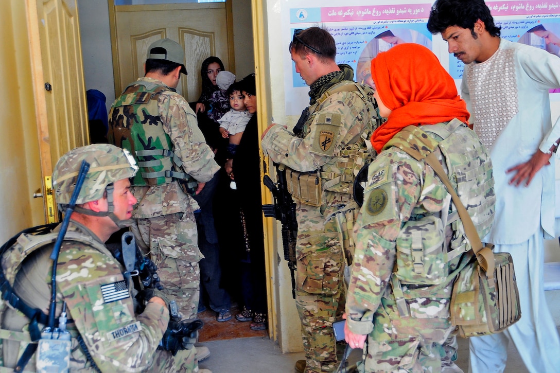 U.S. Army Capt. Sean Eakin, third from right, conducts interviews ...