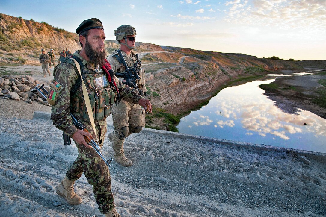 An Afghan army sergeant, left, and U.S. Army Staff Sgt. Jacob Hurndon ...