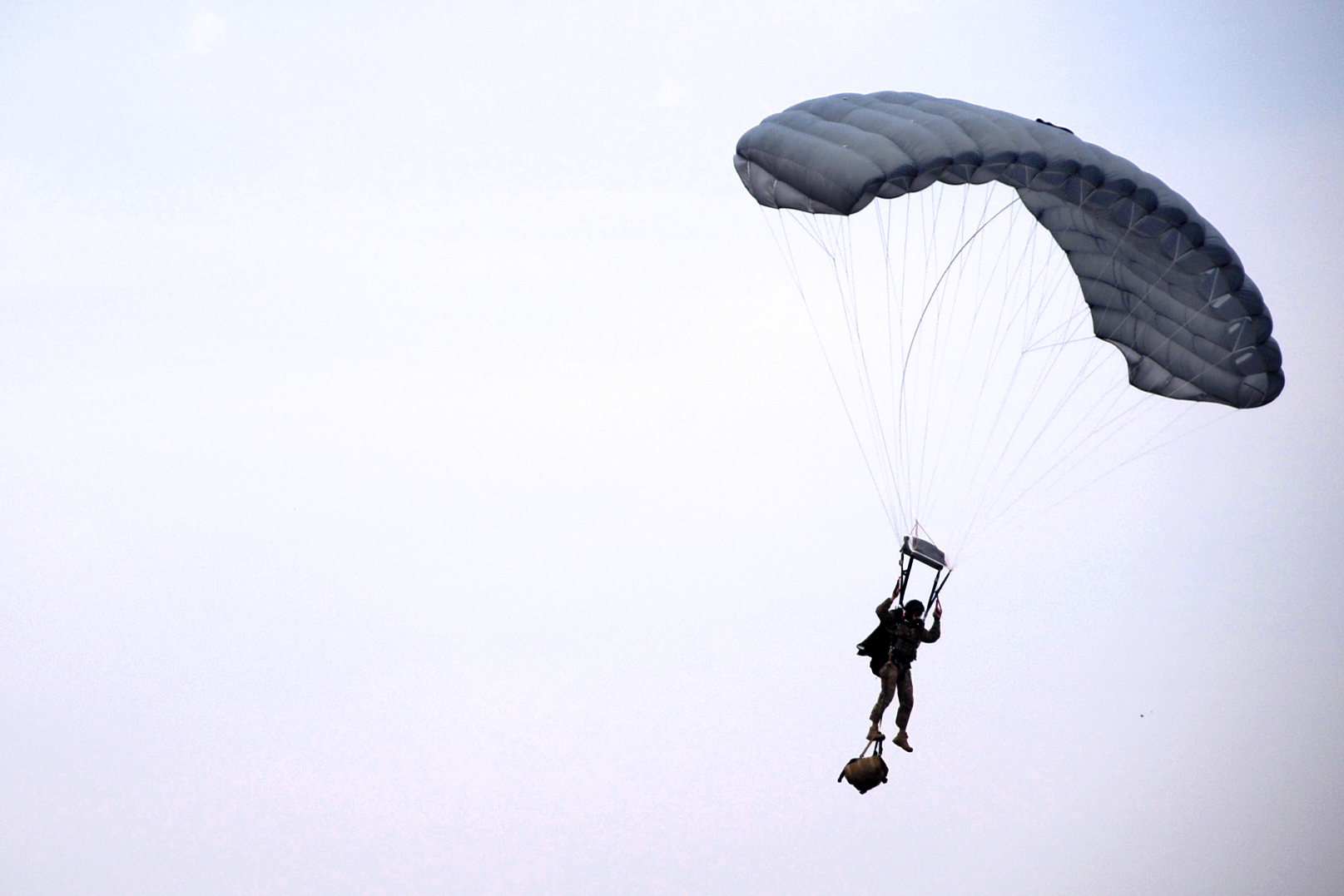 A U.S. Air Force pararescueman freefalls with a parachute after jumping ...