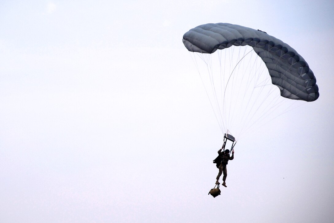 A U.S. Air Force pararescueman freefalls with a parachute after jumping ...