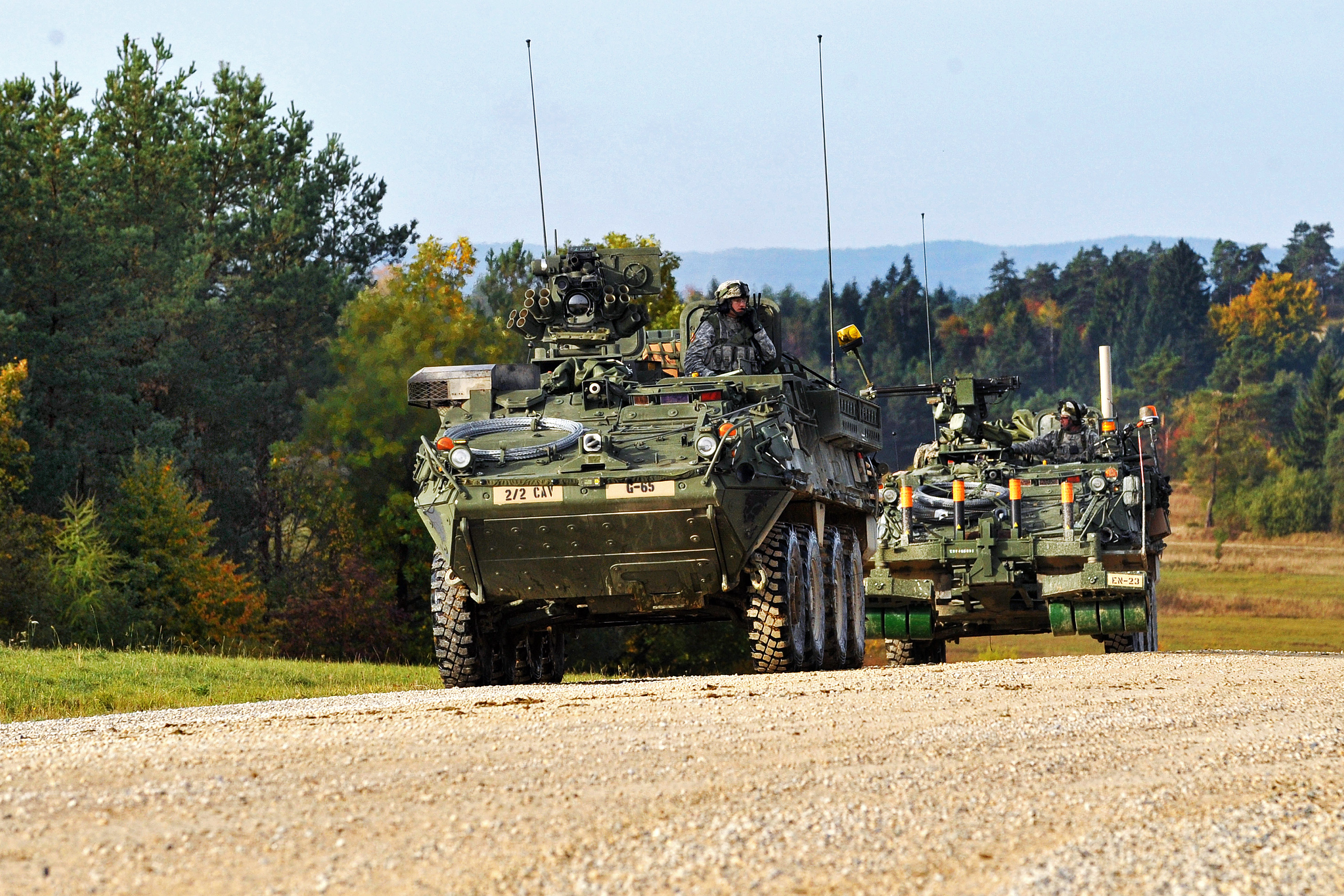 Two Stryker combat vehicles travel a tank trail during Saber Junction ...