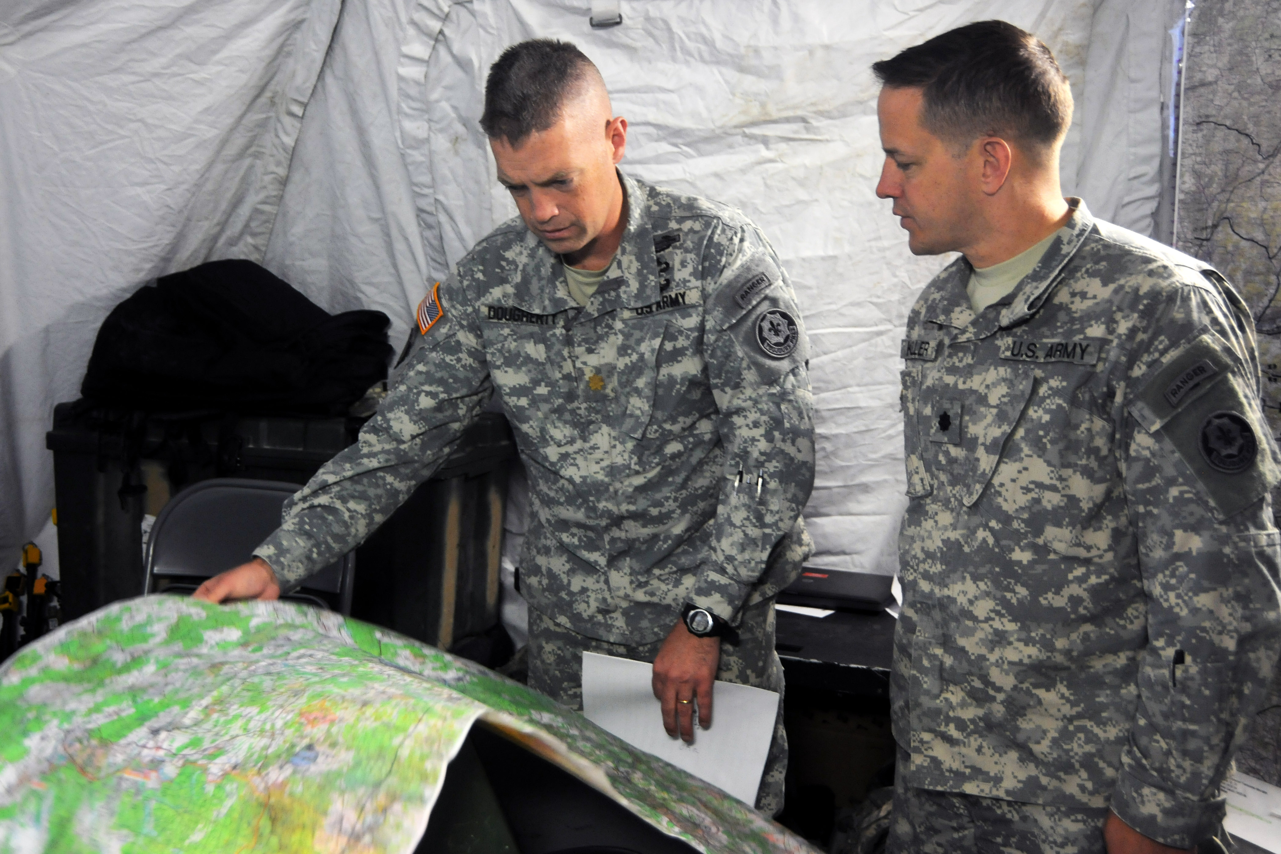 U.S. Army Lt. Col. Steven Keller, right, and Maj. William Dougherty ...