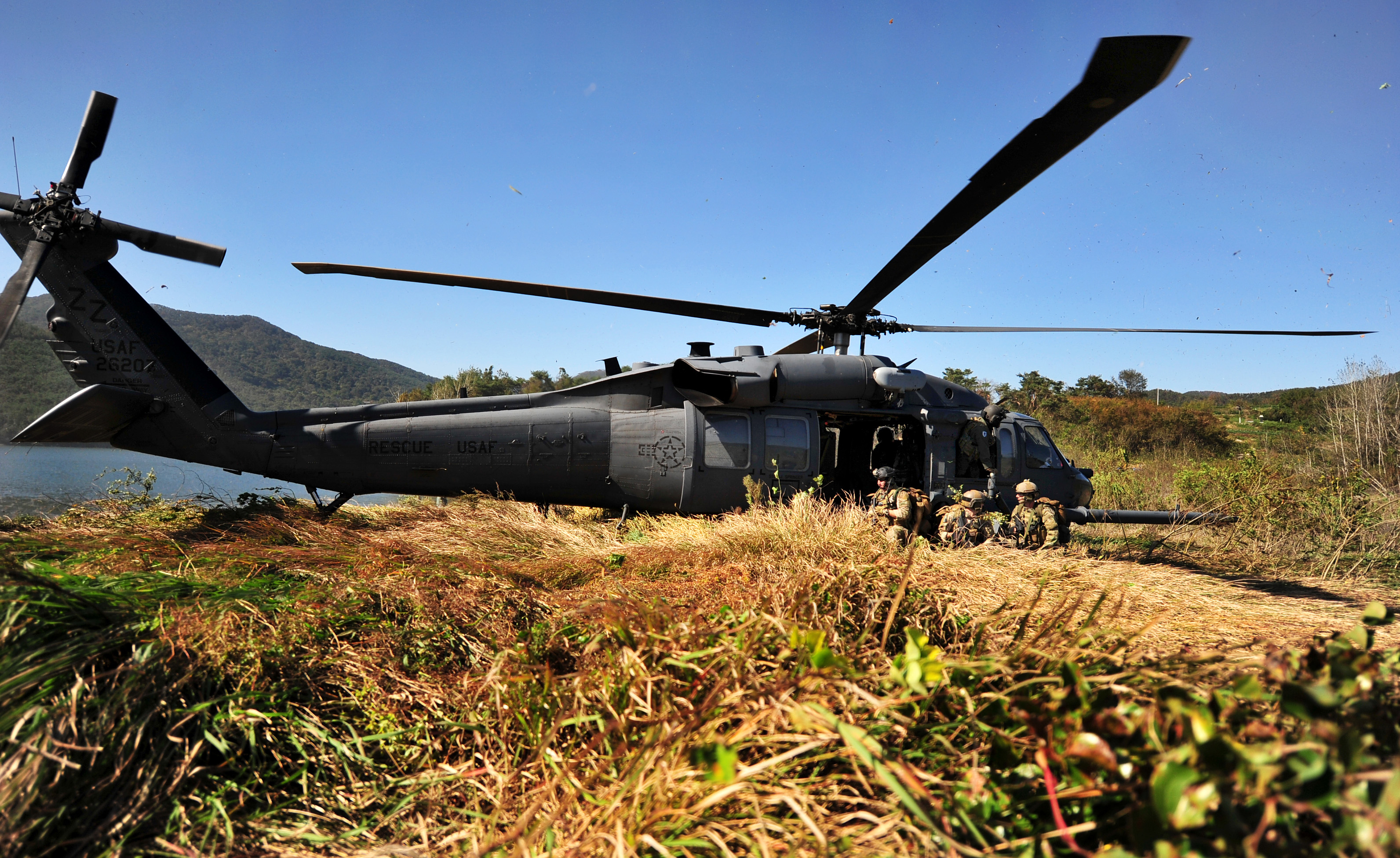 A U.S. Air Force combat rescue officer and three pararescuemen are ...