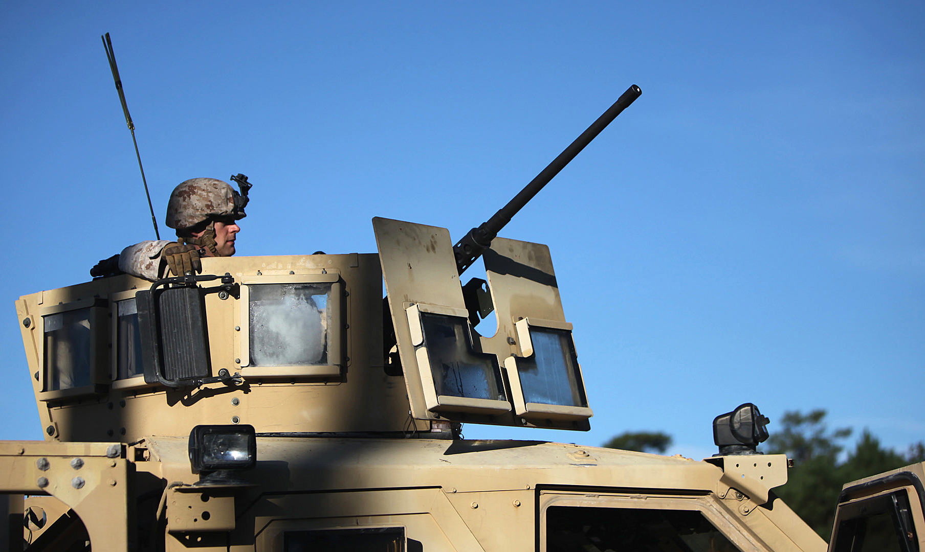 Marine Corps Capt. Devaunt LeClaire prepares a .50 caliber machine gun ...