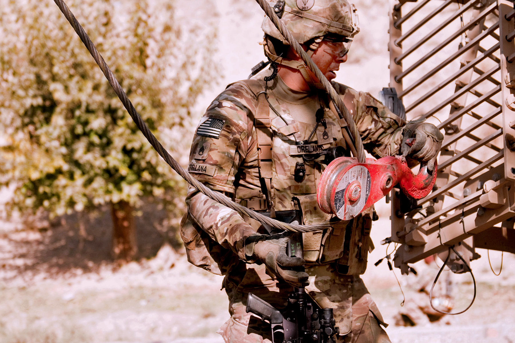 U.S. Army Staff Sgt. Jose Orellana hooks up a mine-resistant, ambush ...