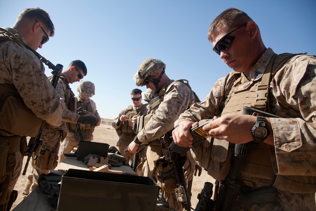 U.S. Marines load magazines at the beginning of a live-fire range on ...