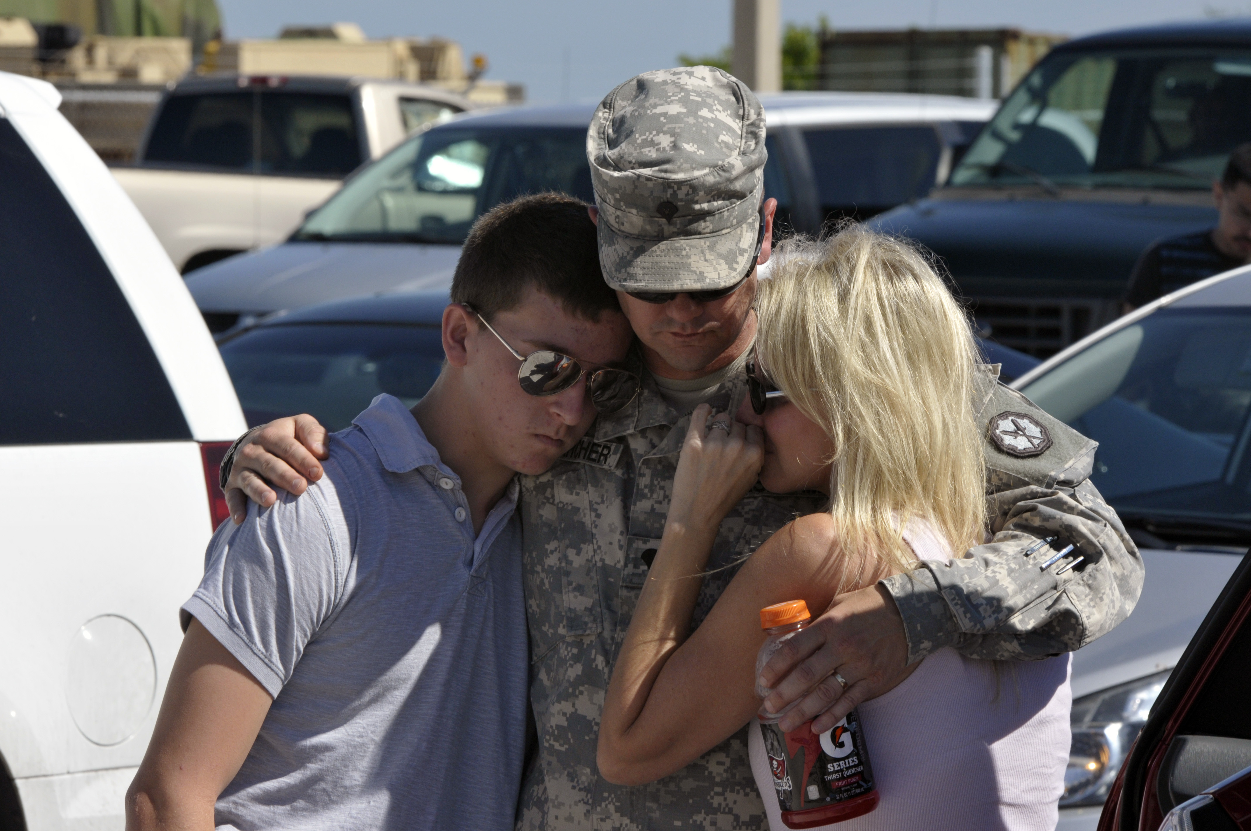 Army Spc. Donald Starcher hugs his wife, Stephanie, and son, Rick ...