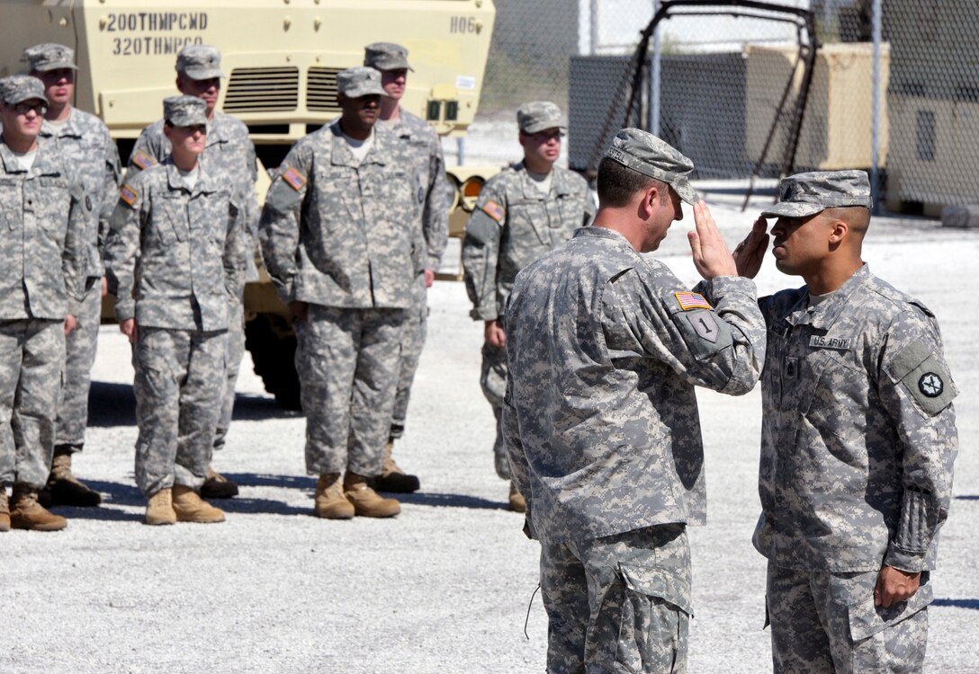 Army Capt. Douglas Worstell salutes 1st Sgt. Sammie L. McCall during ...