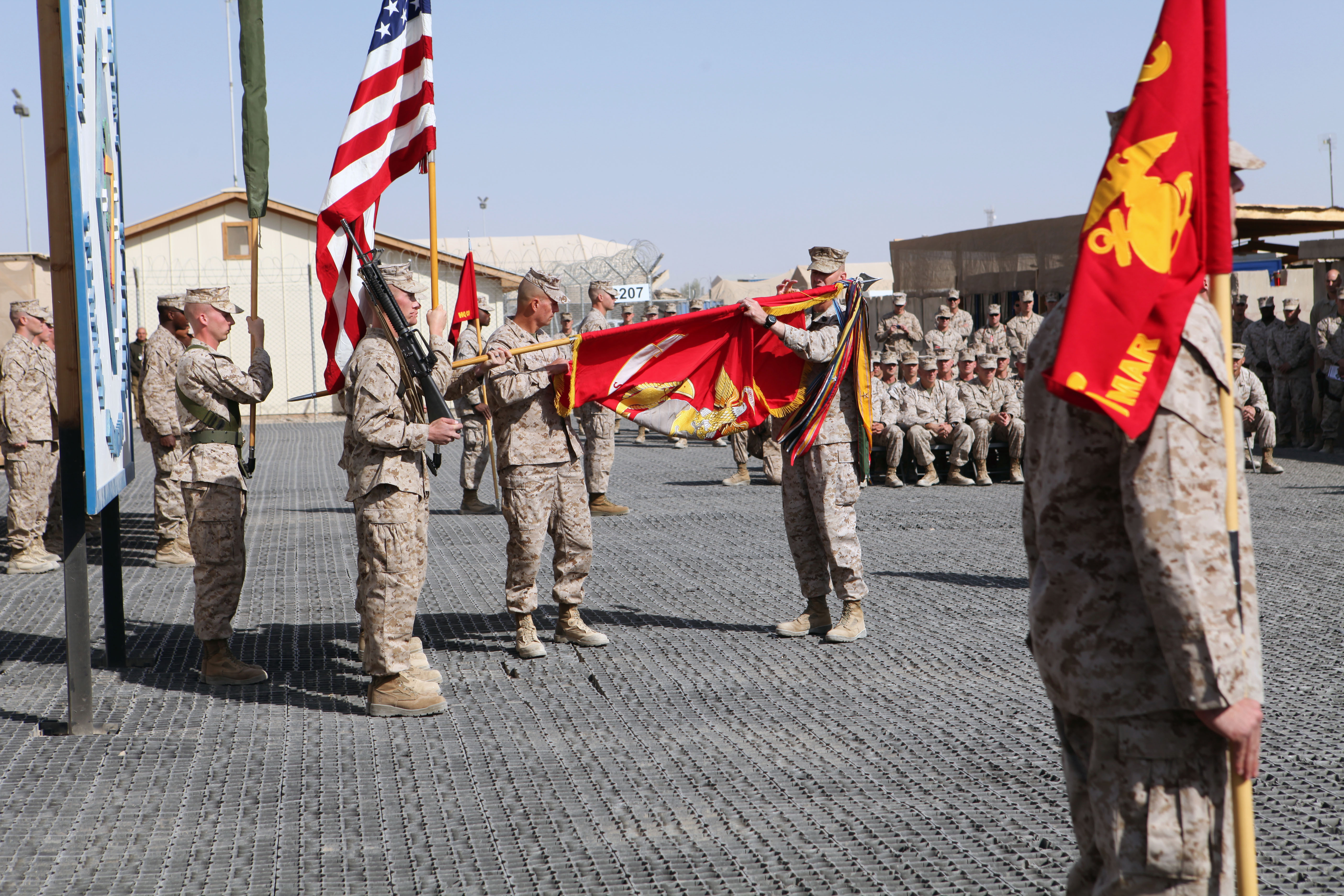 U.S. Marine Corps Col. John Shafer and Sgt. Maj. Jamie Deets fold the ...