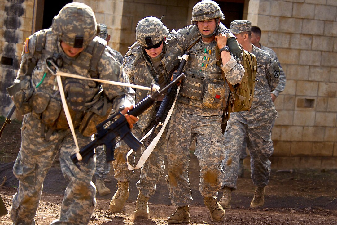 Army Sgts. Justin Runyan, right, and Robert Edwards, left, move ...