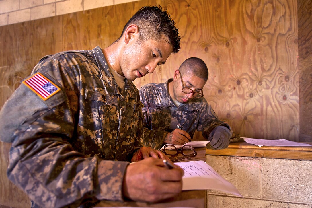 Army Sgt. Fernando Diaz, right and Pfc. Joshua Yi, left, complete a 100 ...