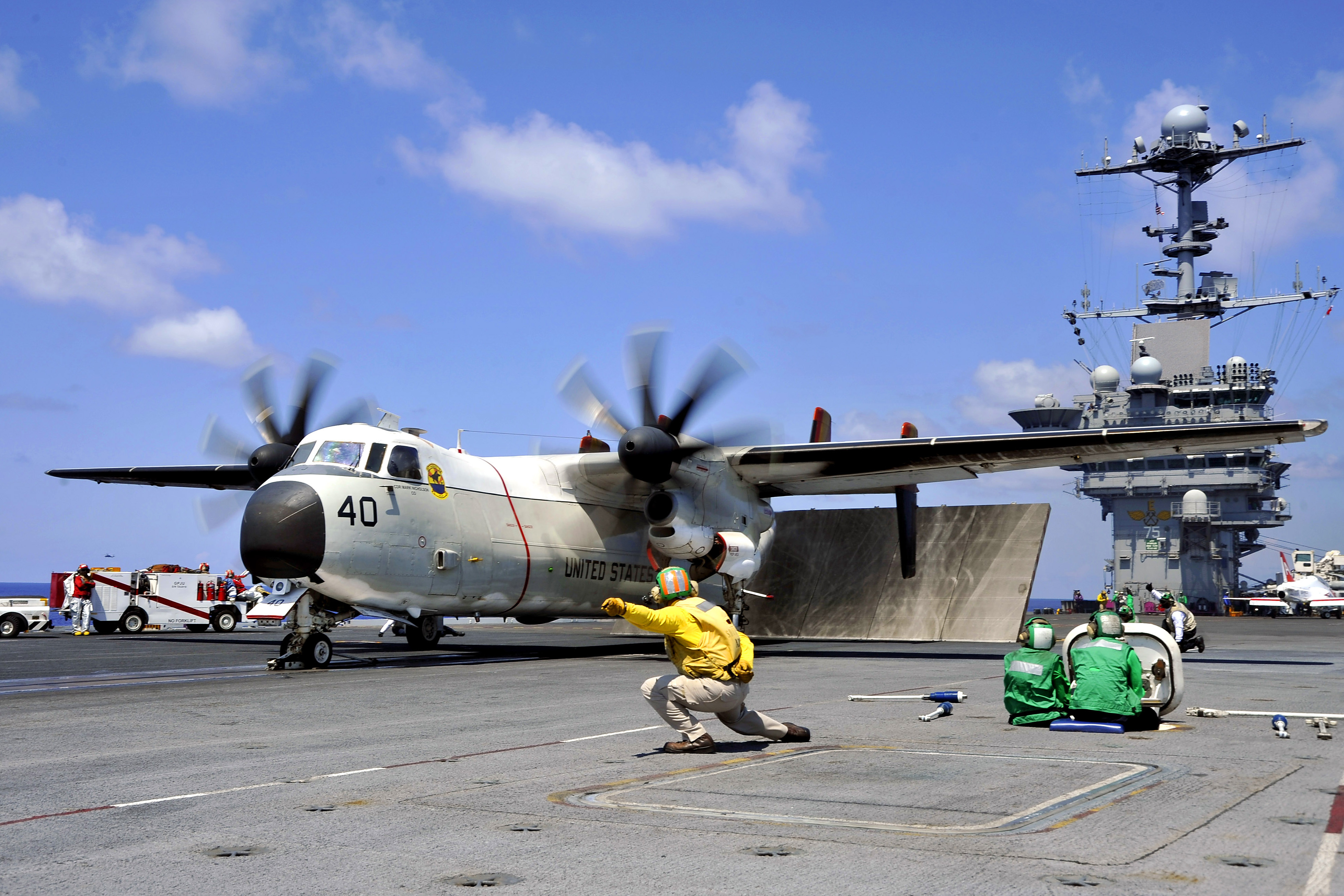 An aircraft launch and recovery officer, commonly referred to as a ...