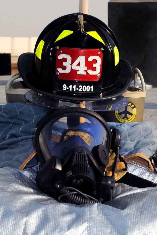 A firefighter's helmet and mask serve as reminders of the sacrifices ...
