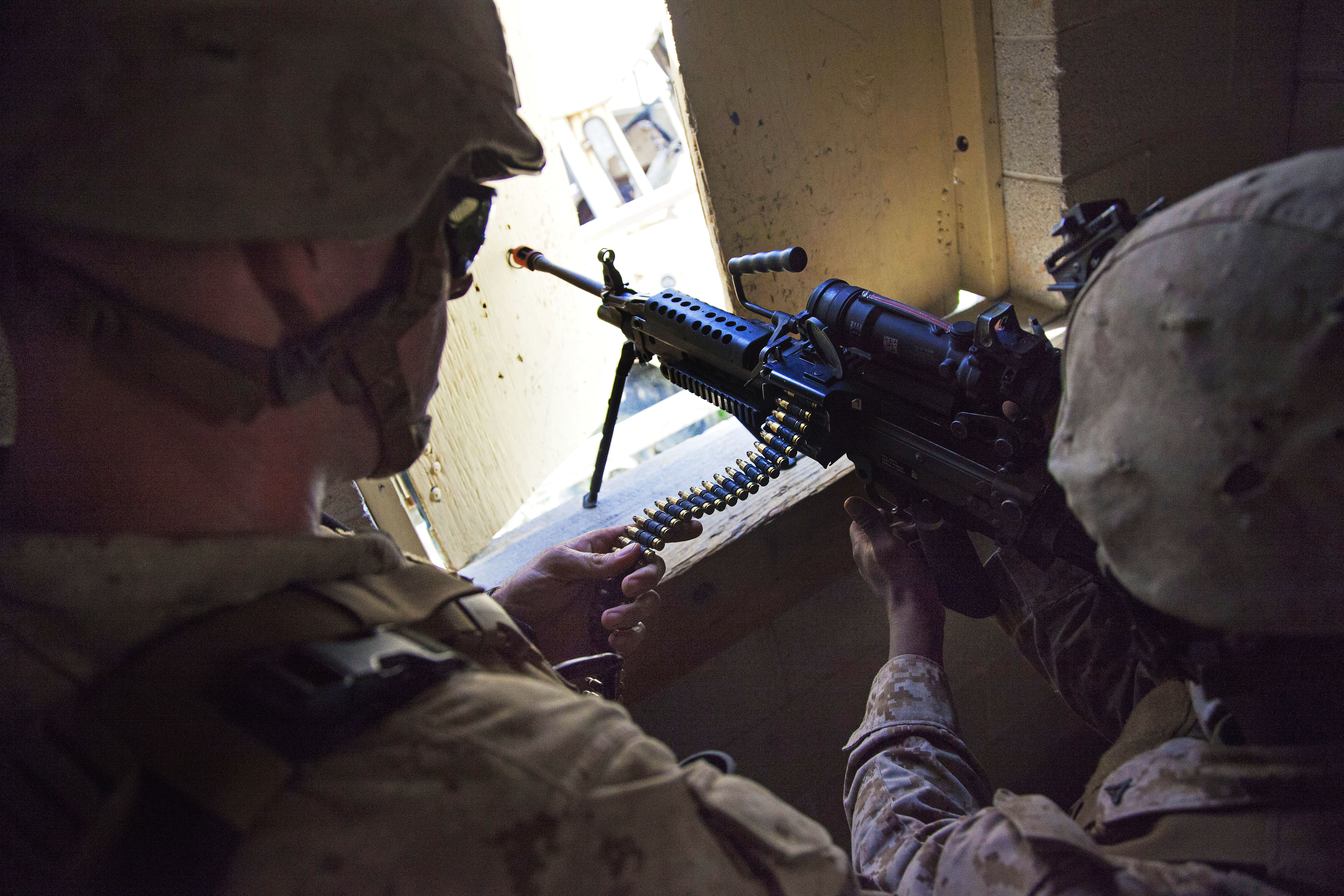 A Marine holds ammunition for an M249 squad automatic weapon as his ...