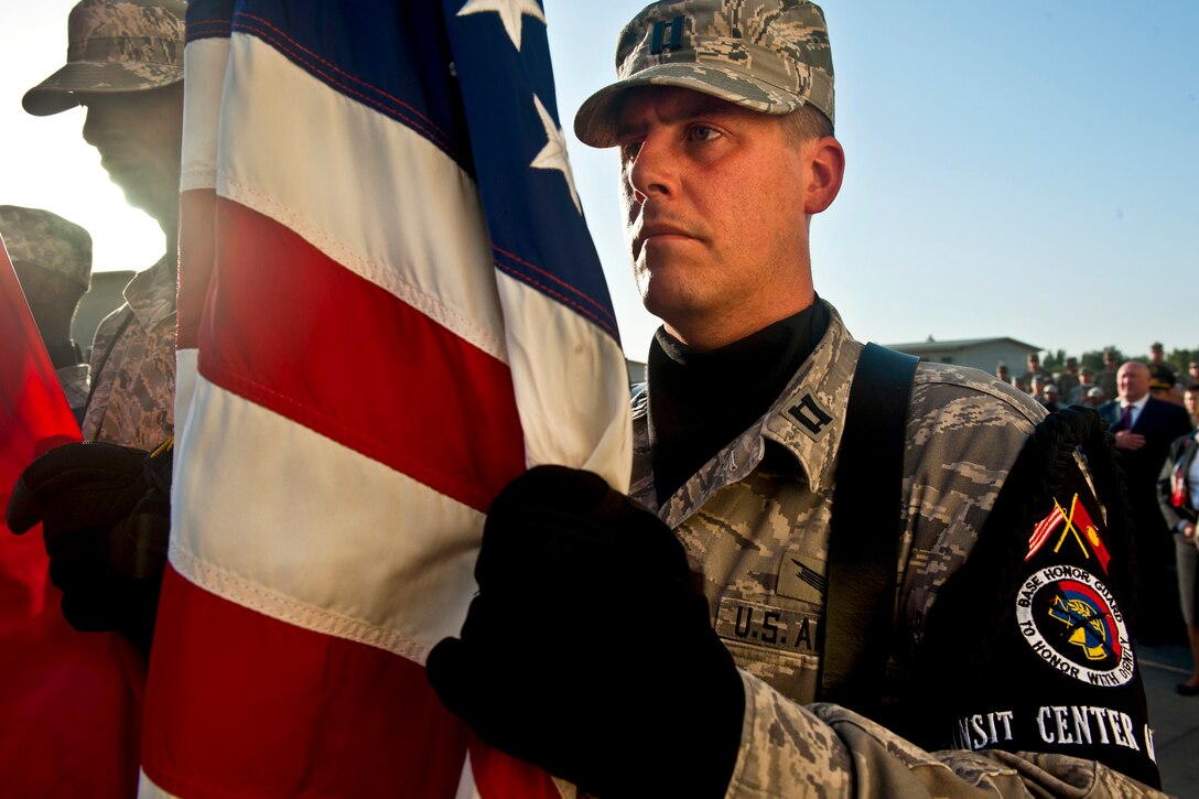 U.S. Air Force Capt. Ryan Kerr posts the colors with fellow service ...