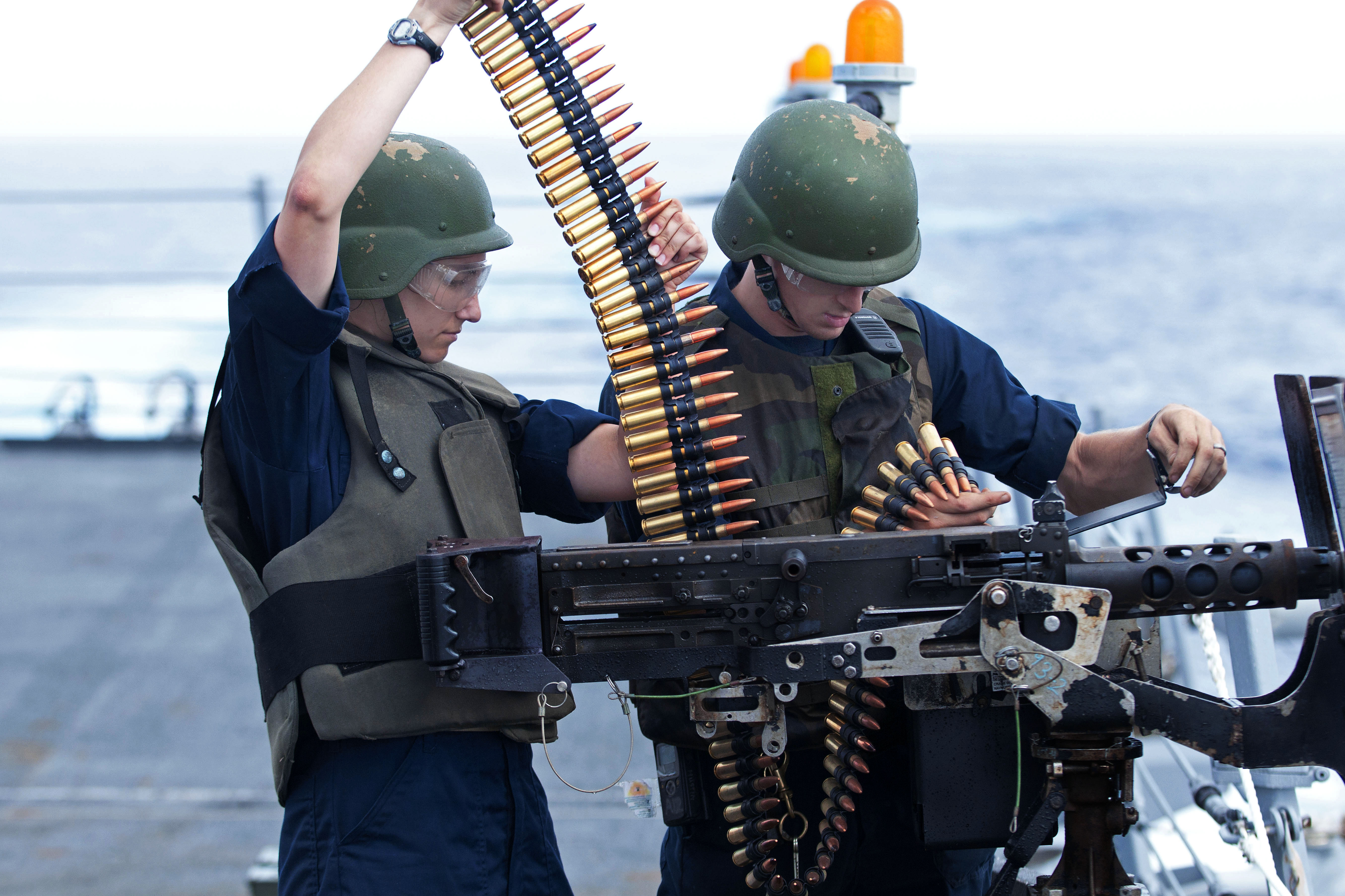 U.S. Navy Ensign Carmen Houk, left, and U.S. Navy Petty Officer 1st ...