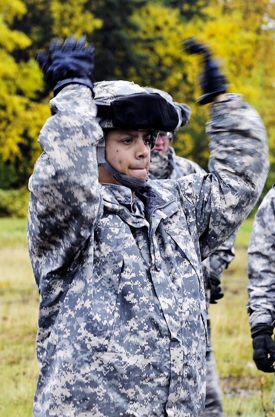 Army Spc. John Luna rehearses his hand signals as his unit prepares to ...