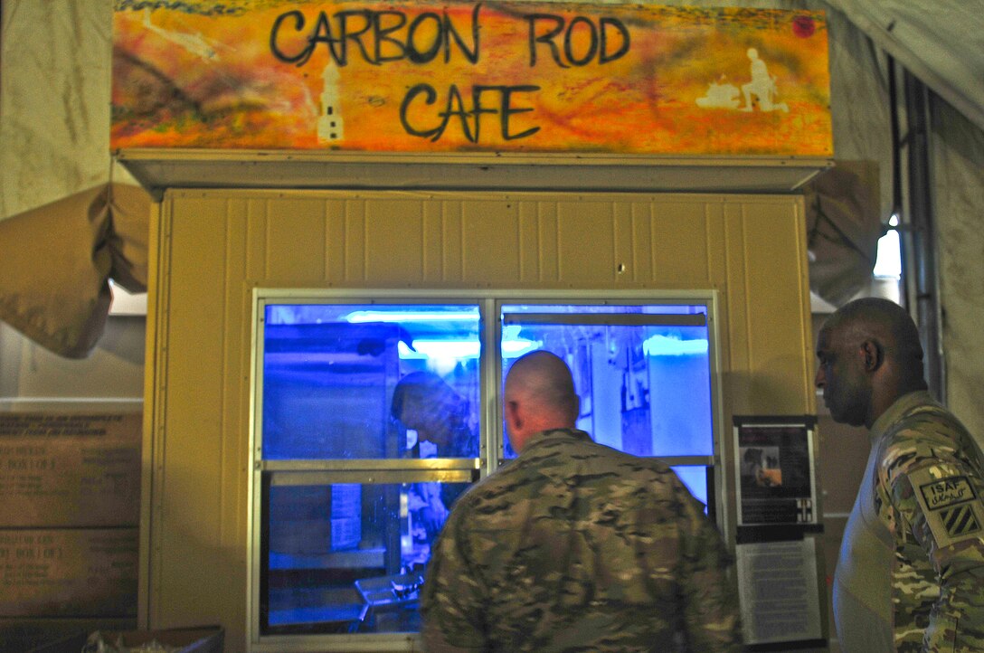 U.S. Army Command Sgt. Maj. Frank A. Grippe, left, command senior ...