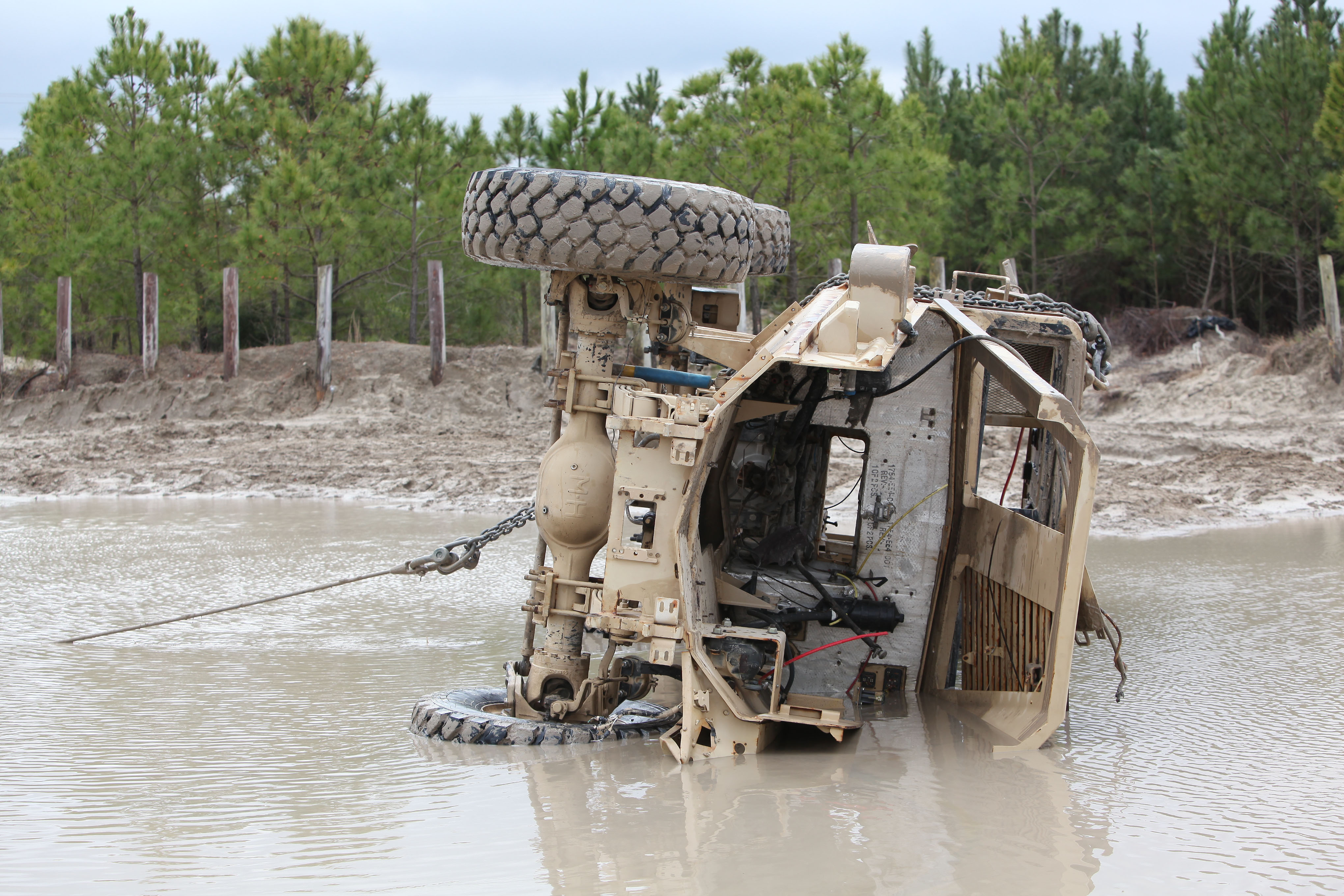 A Mine Resistant Ambush Protected vehicle, or M-ATV, sits on its side ...