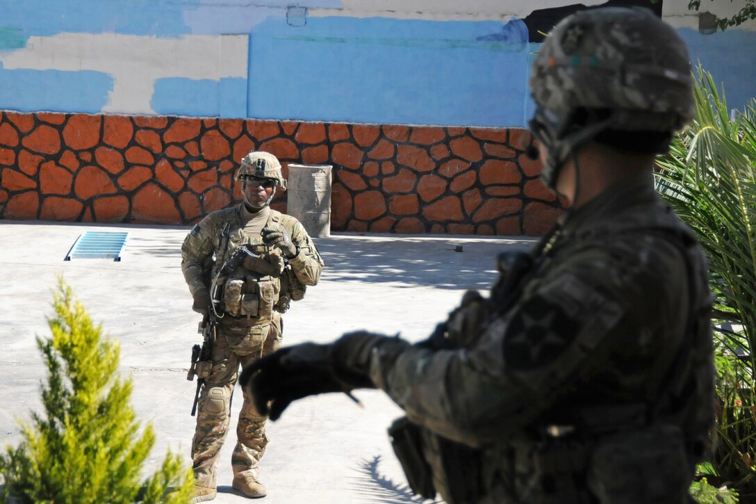 U.S. Army 1st Lt. Robert Wolfe, right, talks with U.S. Army Staff Sgt ...