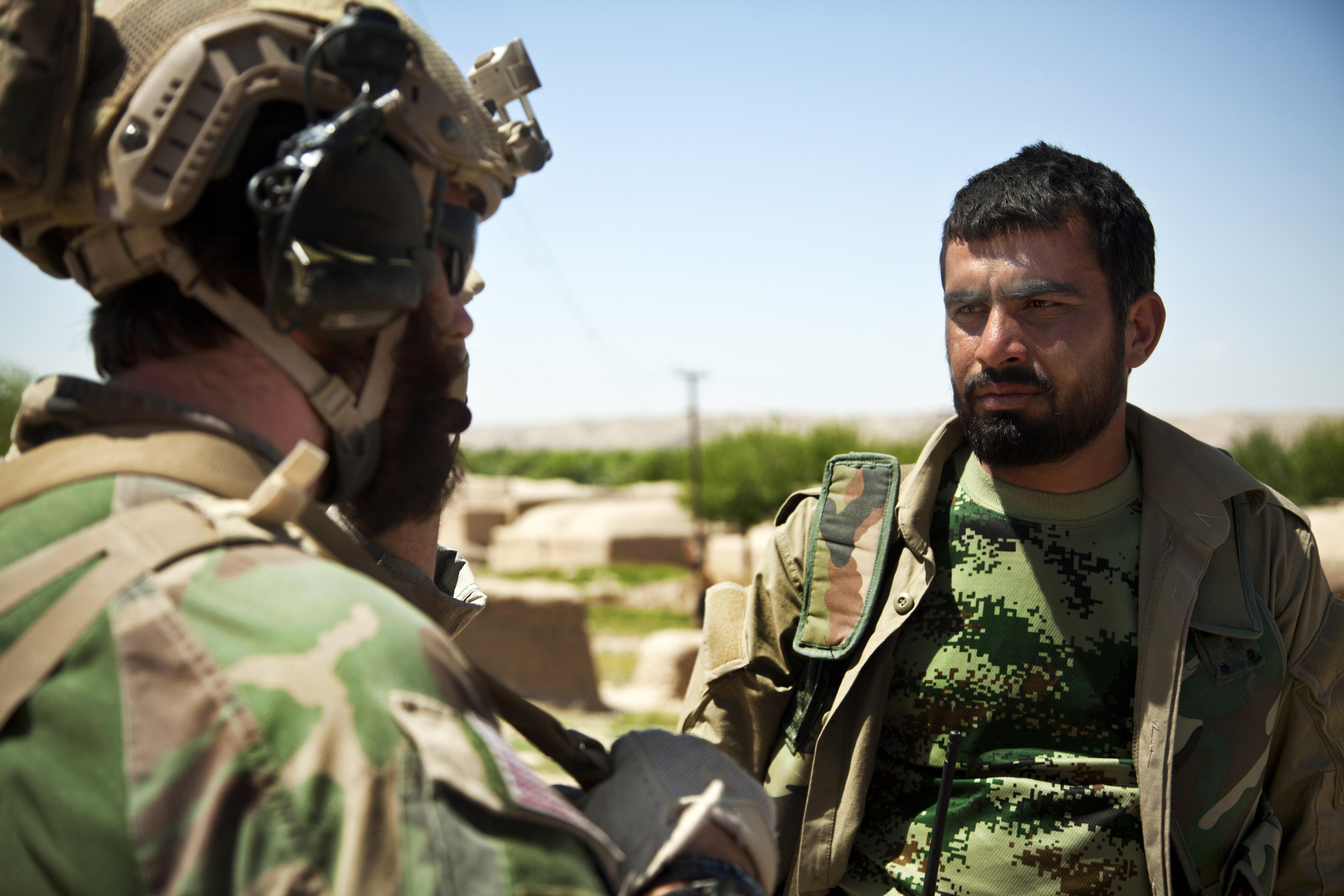 A U.S. Marine Corps Special Operations team member speaks with an ...