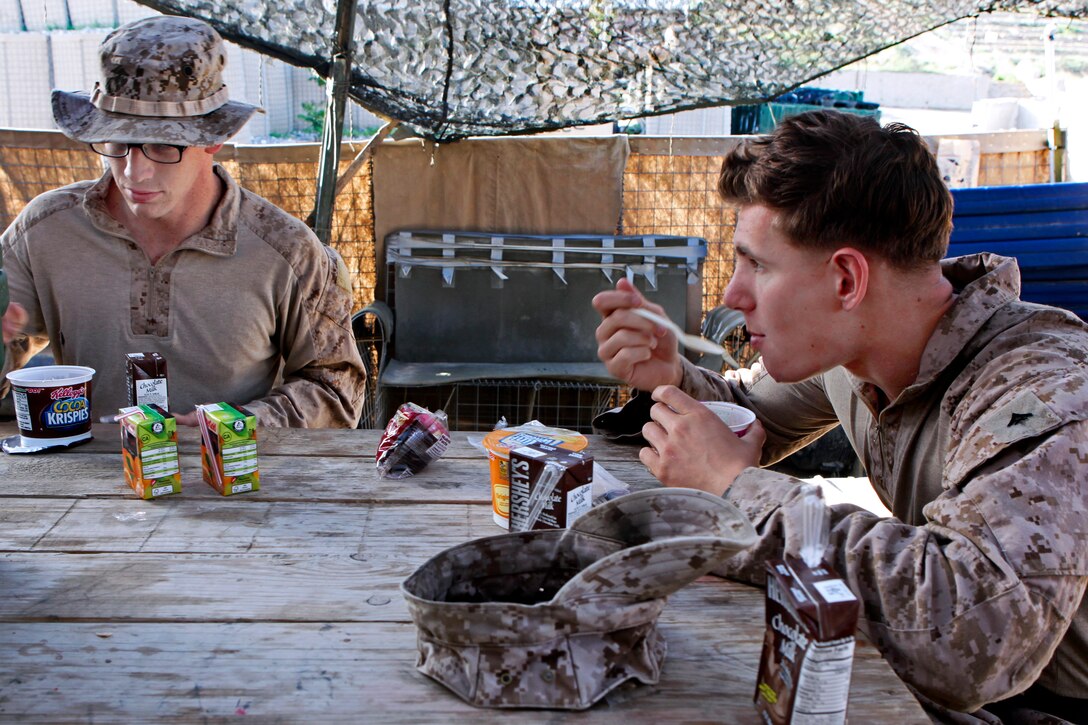 U.S. Marine Corps Lance Cpl. Robert Carroll, right, and U.S. Navy Petty ...