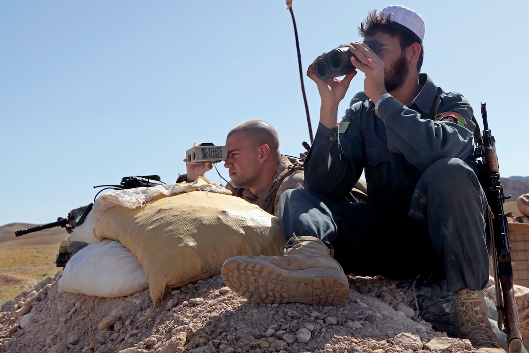 U.S. Marine Corps 1st Lt. Roger Hyde, left, and an Afghan police ...