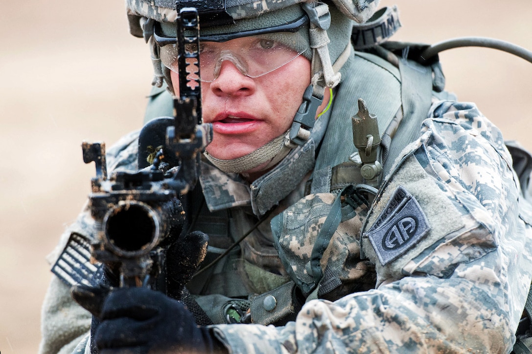 Army Pfc. Travis Williams aims his M320 grenade launcher during a ...