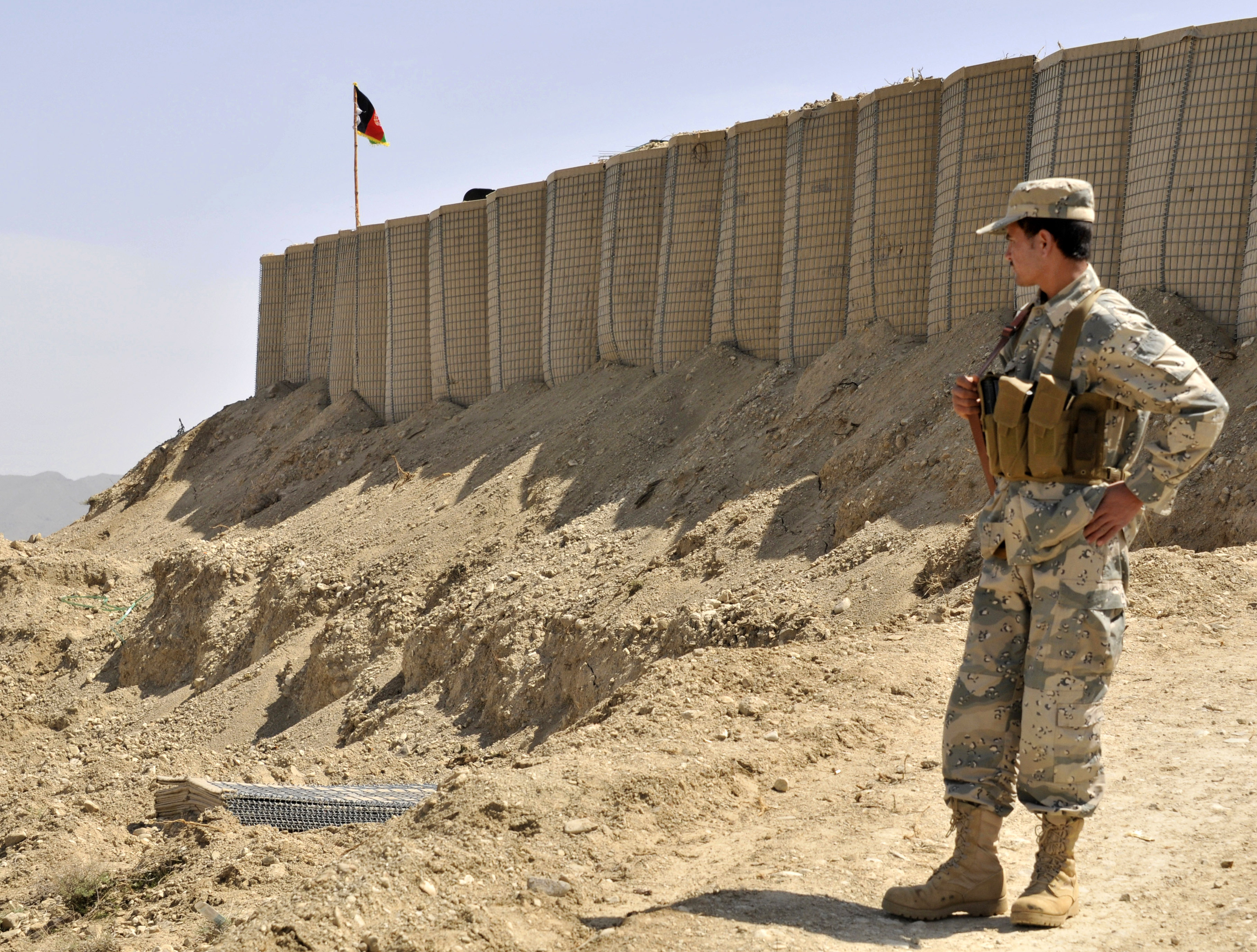 An Afghan border policeman stands watch near the entrance to a new ...