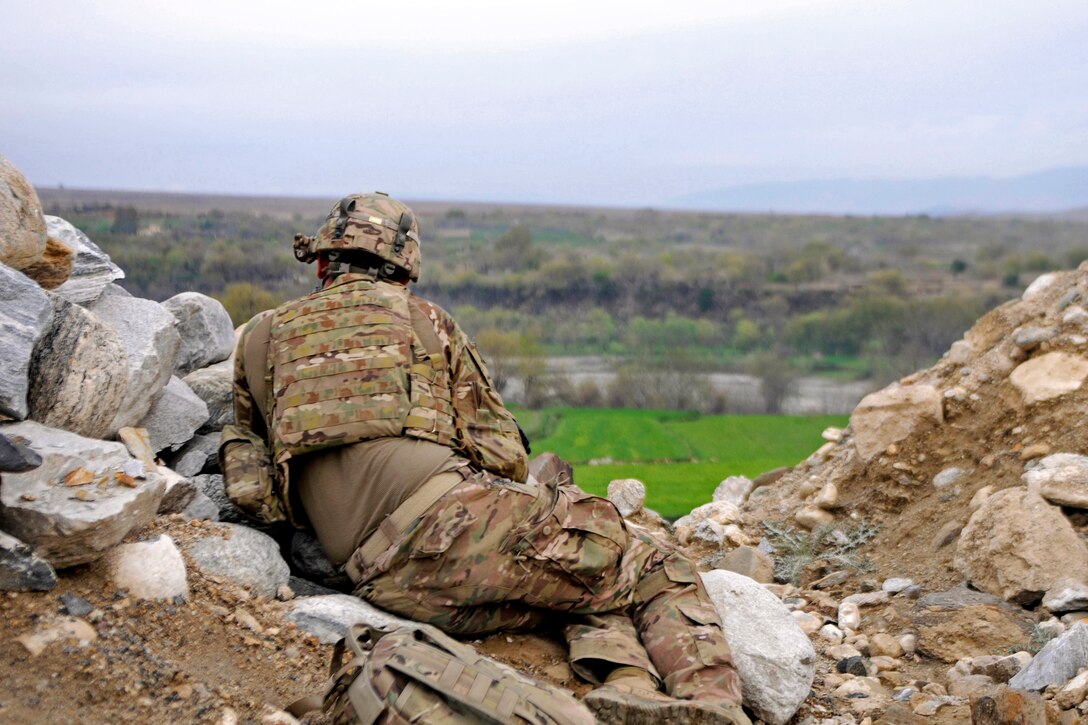 U.S. Army Spc. Gary Lay pulls security on top of a hill in the Khogyani ...