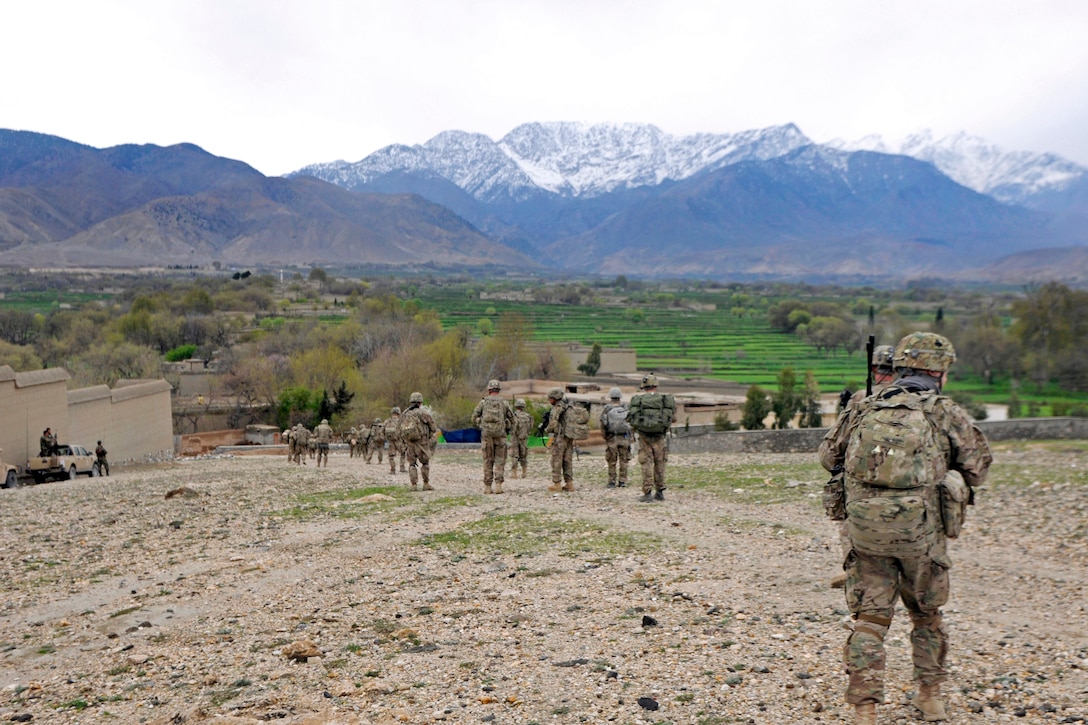 U.S. soldiers move out into a village in the Khogyani district of ...
