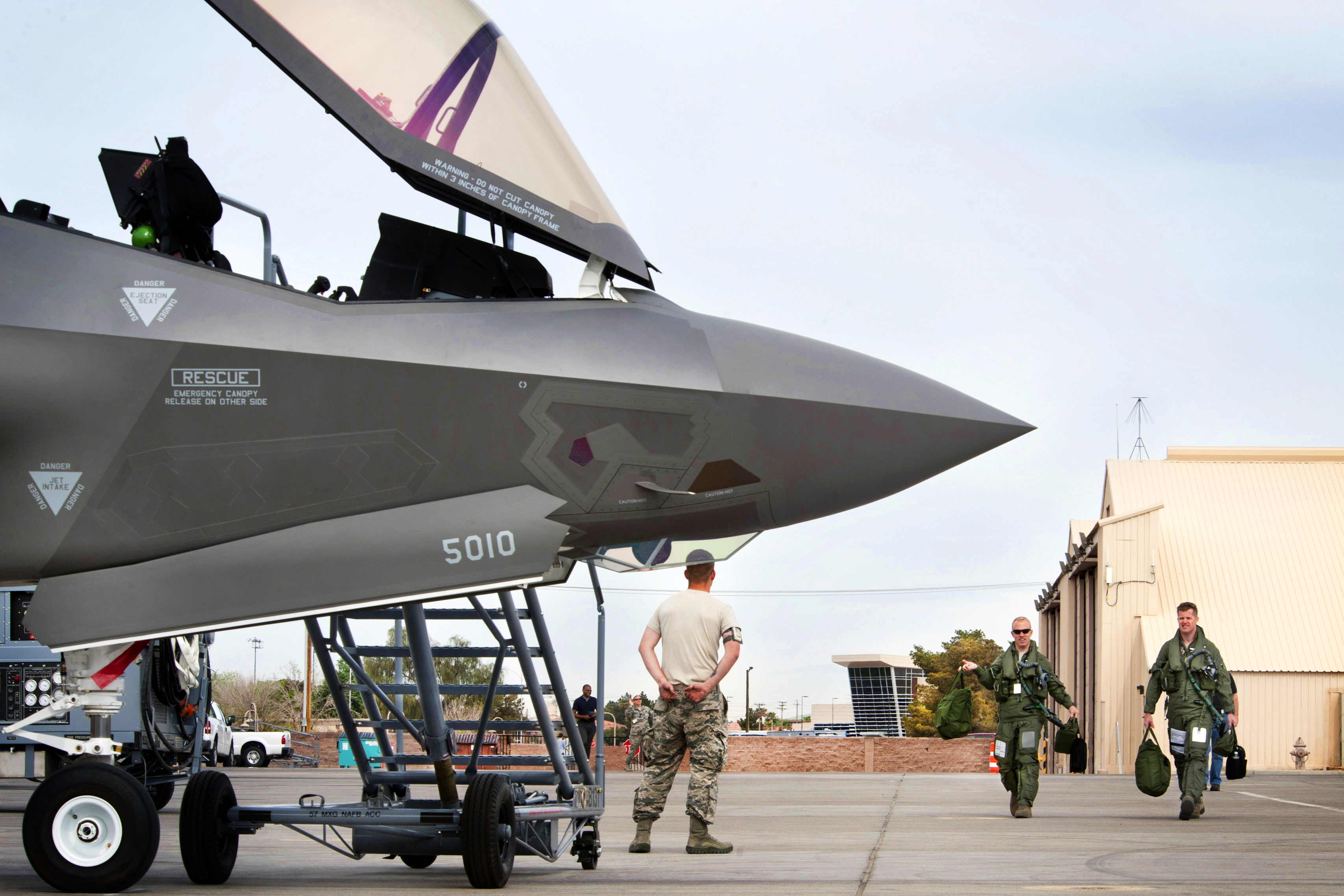 Air Force Staff Sgt. Nicholas Fagerstrom, left, greet Air Force Lt. Col ...