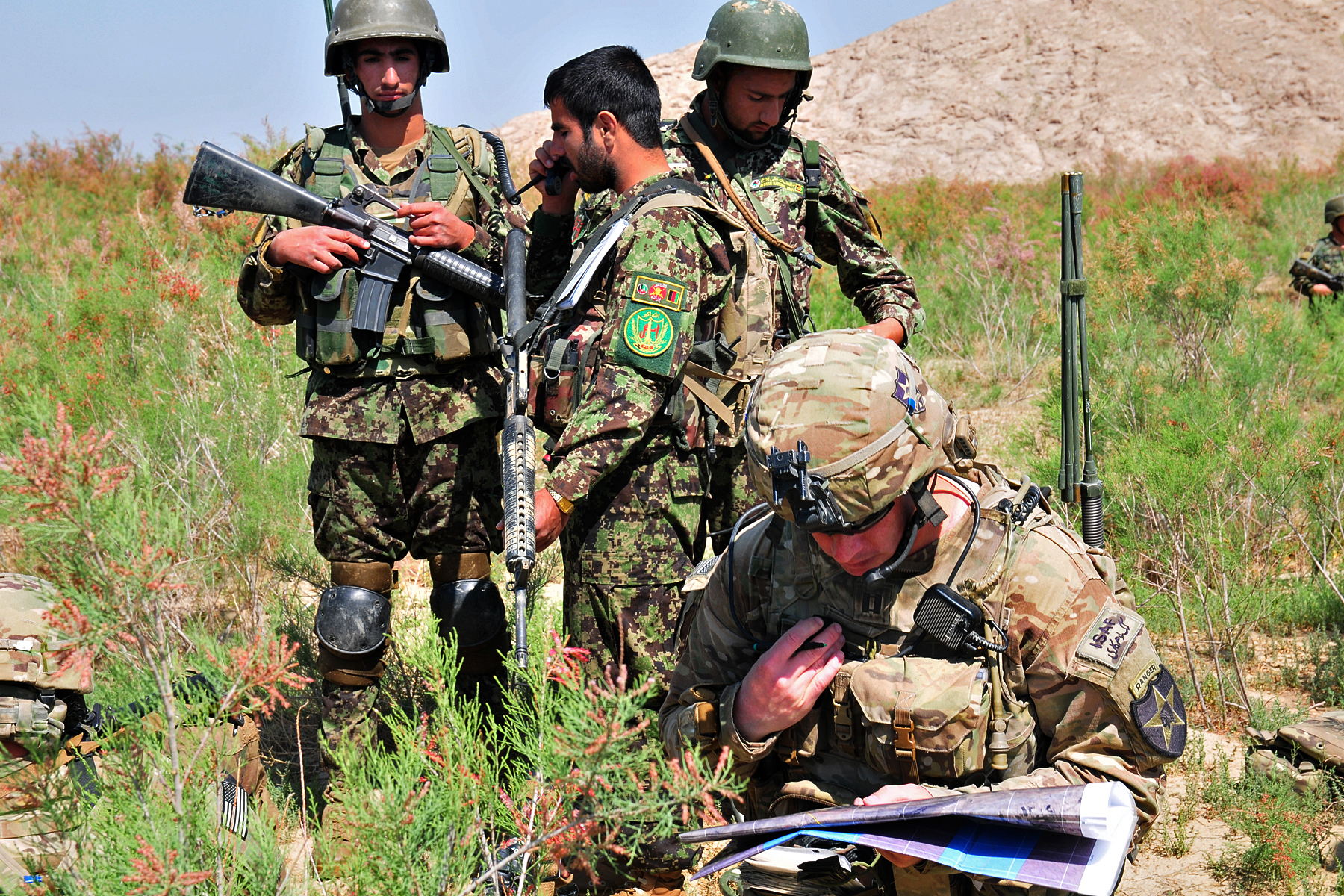 U.S. Army Capt. Ralph Parlin, front, relays information to his company ...