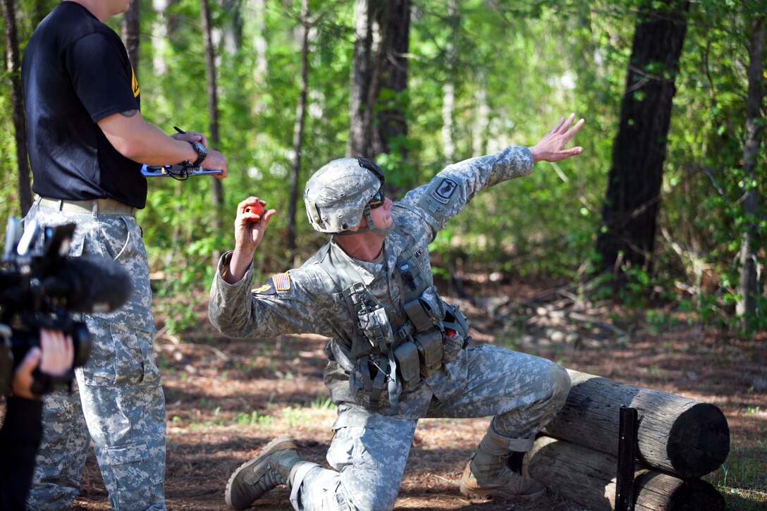 Army Cpl. Kyle Piunti throws a grenade during the grenade assault ...
